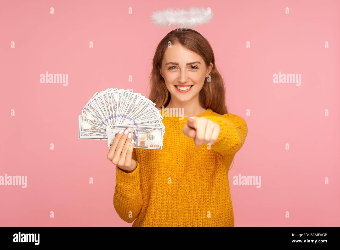 Hey you, make money! Portrait of positive angelic ginger girl with halo ...