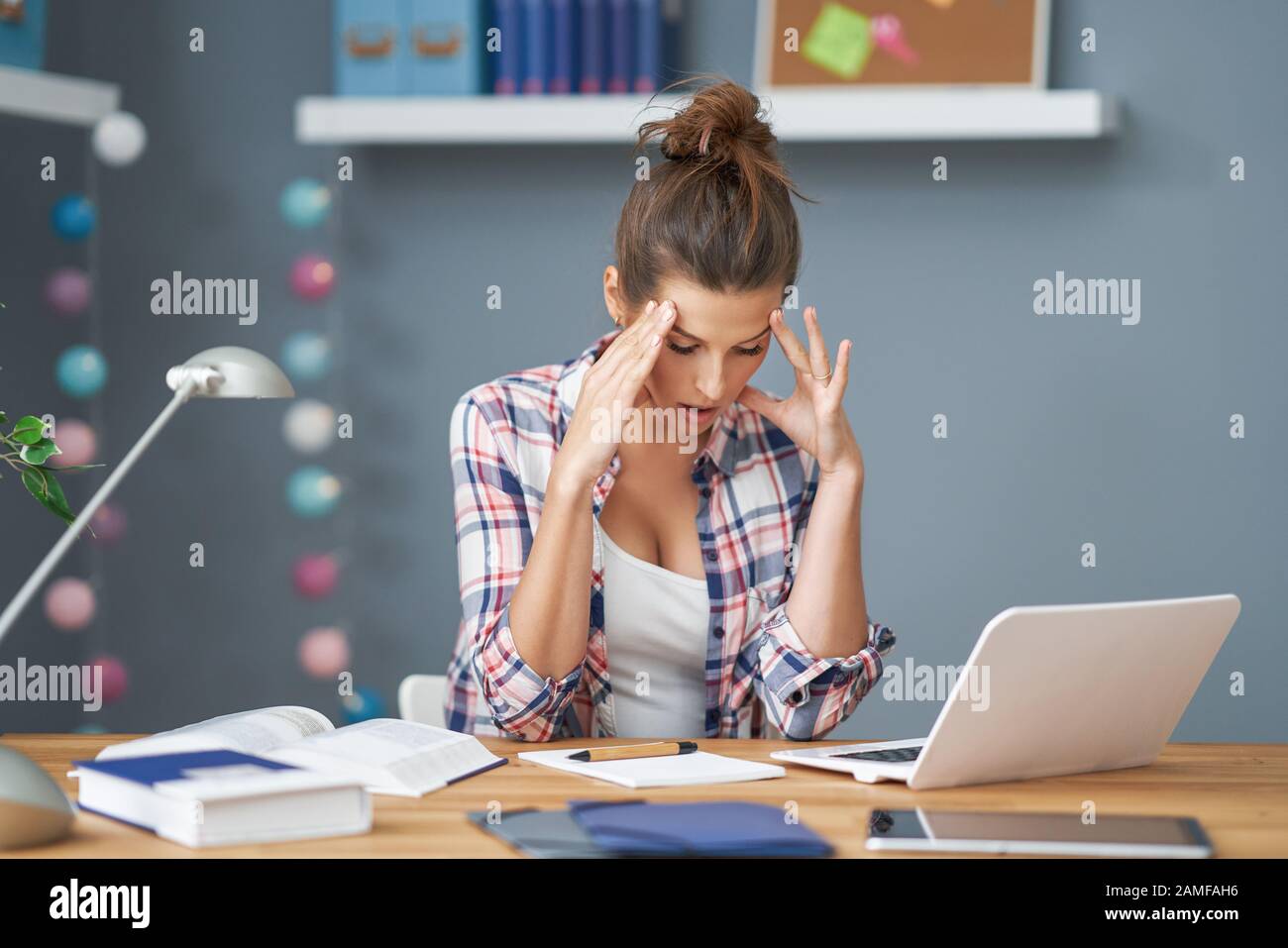 Tired female student learning till late at home Stock Photo - Alamy