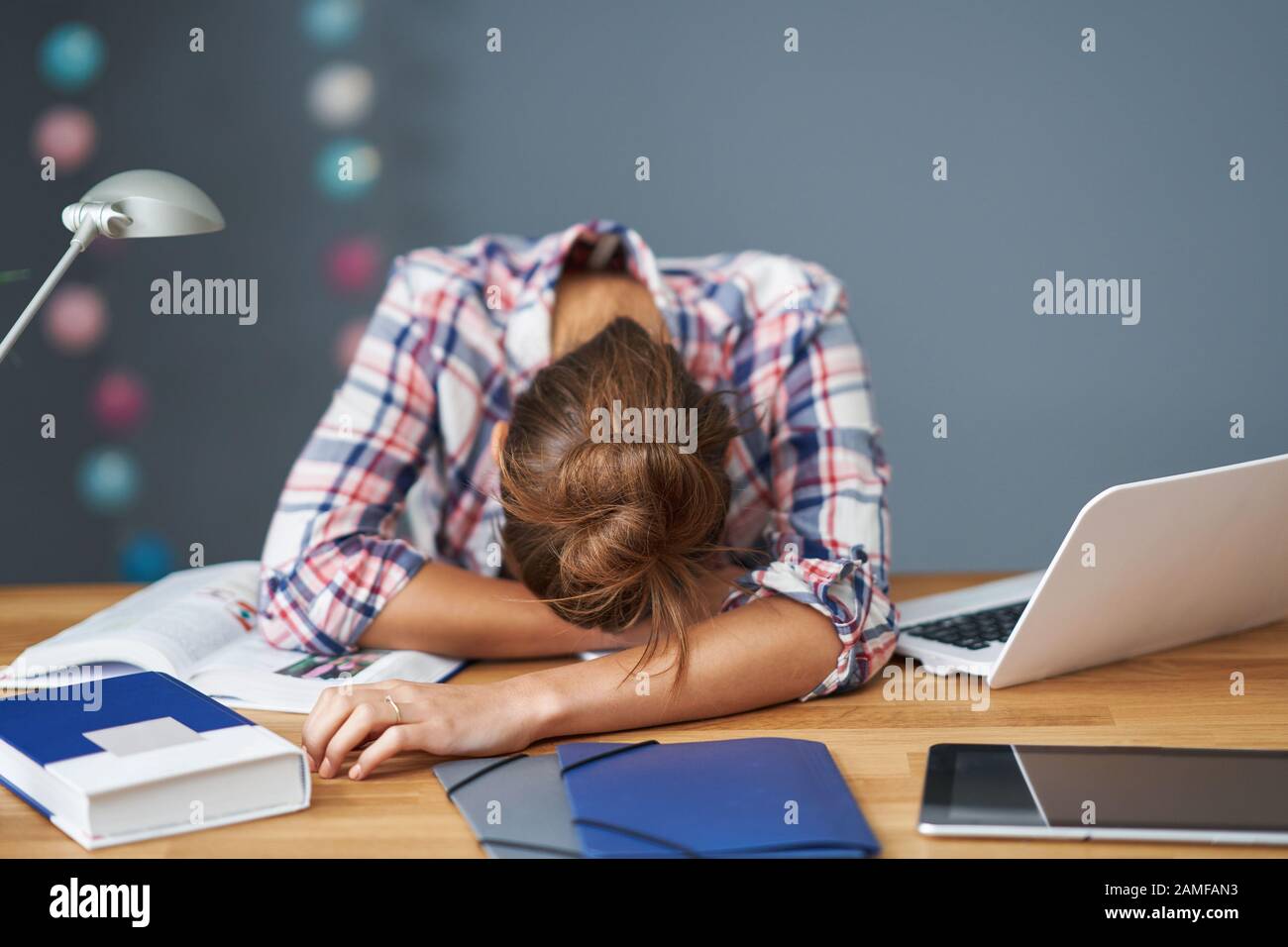 Tired female student learning till late at home Stock Photo - Alamy