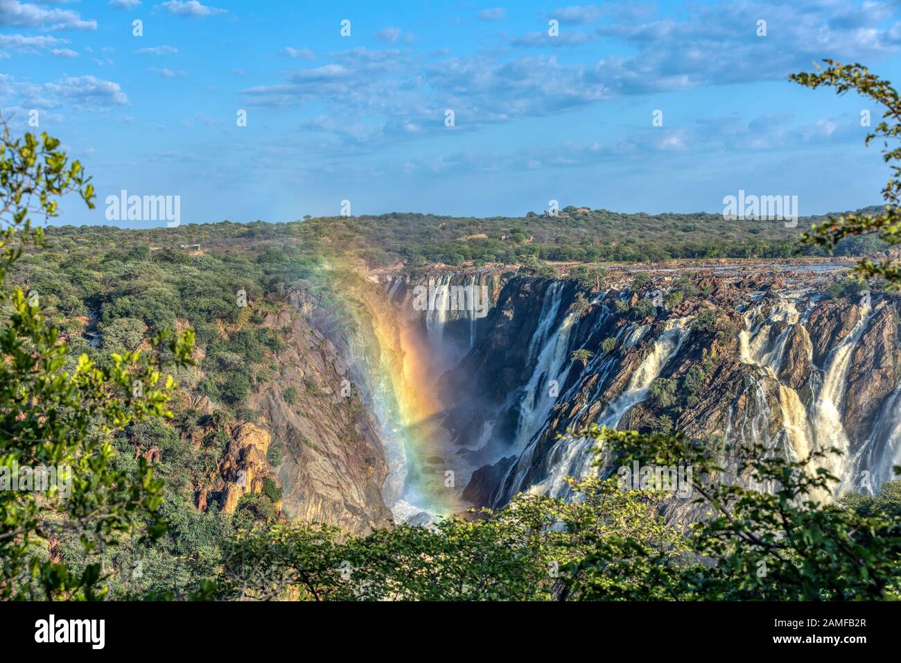 rainbow over landscape of Ruacana Falls on the Kunene River in Northern ...
