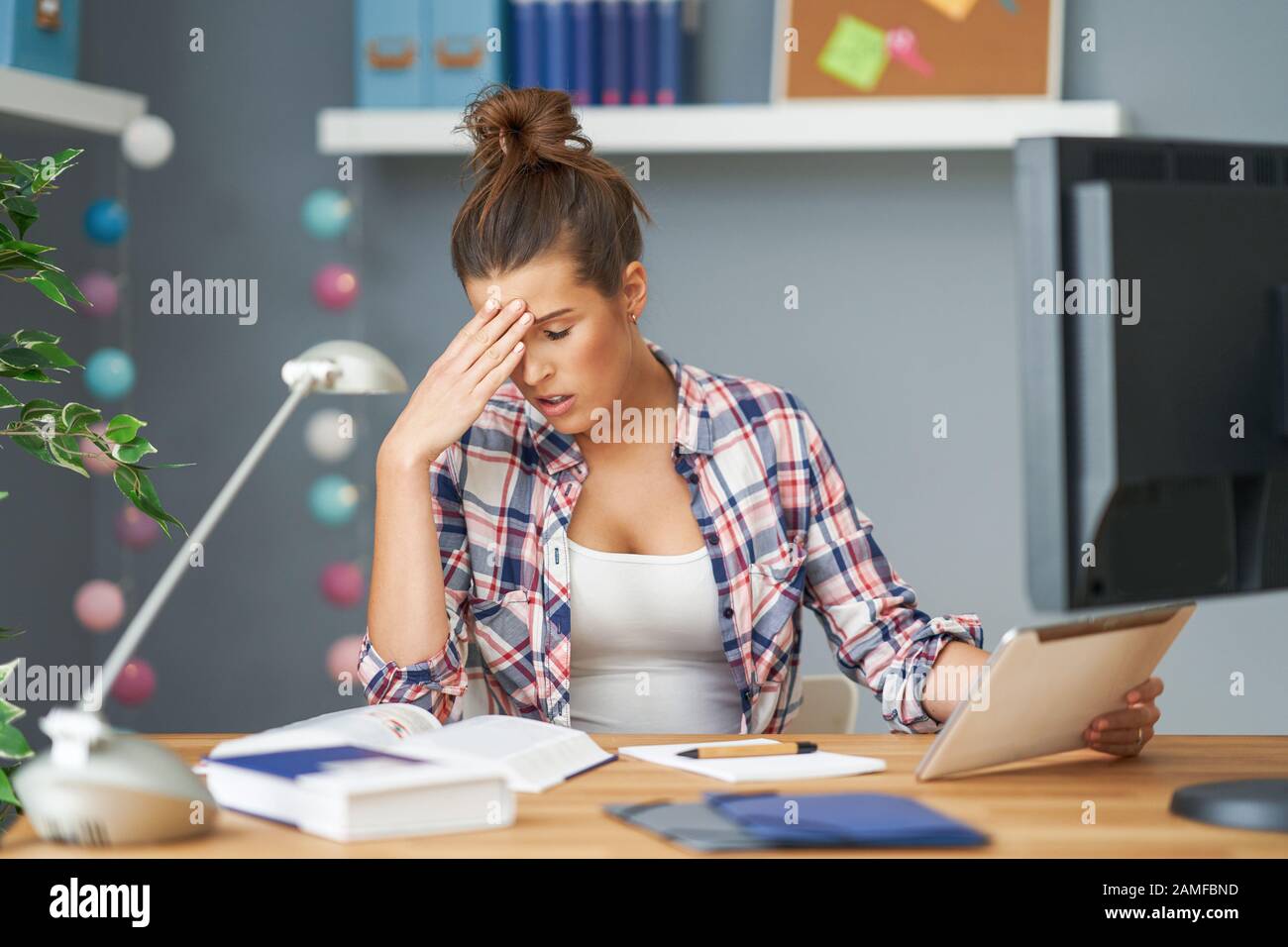 Tired female student learning till late at home Stock Photo - Alamy