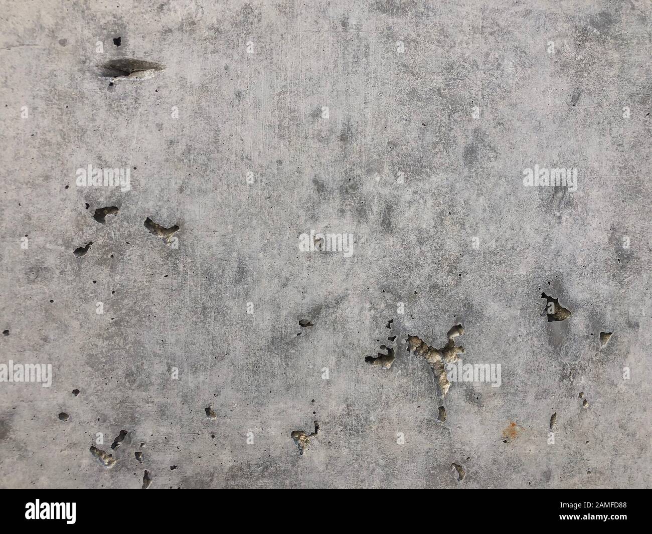 Concrete surface with caverns and exposed gravel stones Stock Photo - Alamy