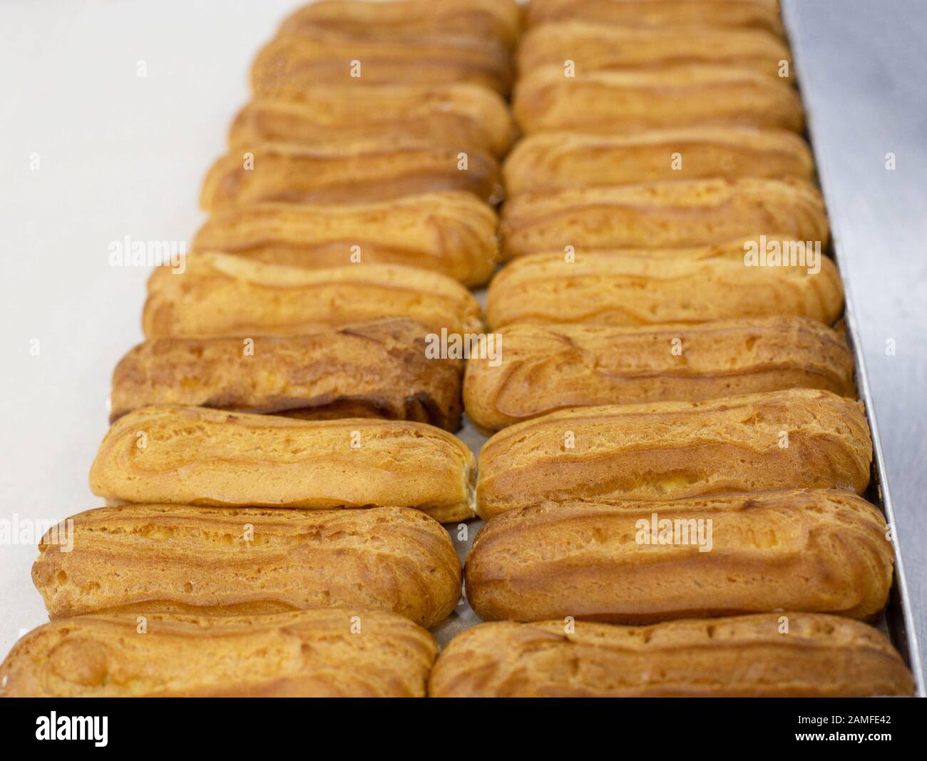 Fresh custard eclairs cakes lie on the table, background, pastry ...