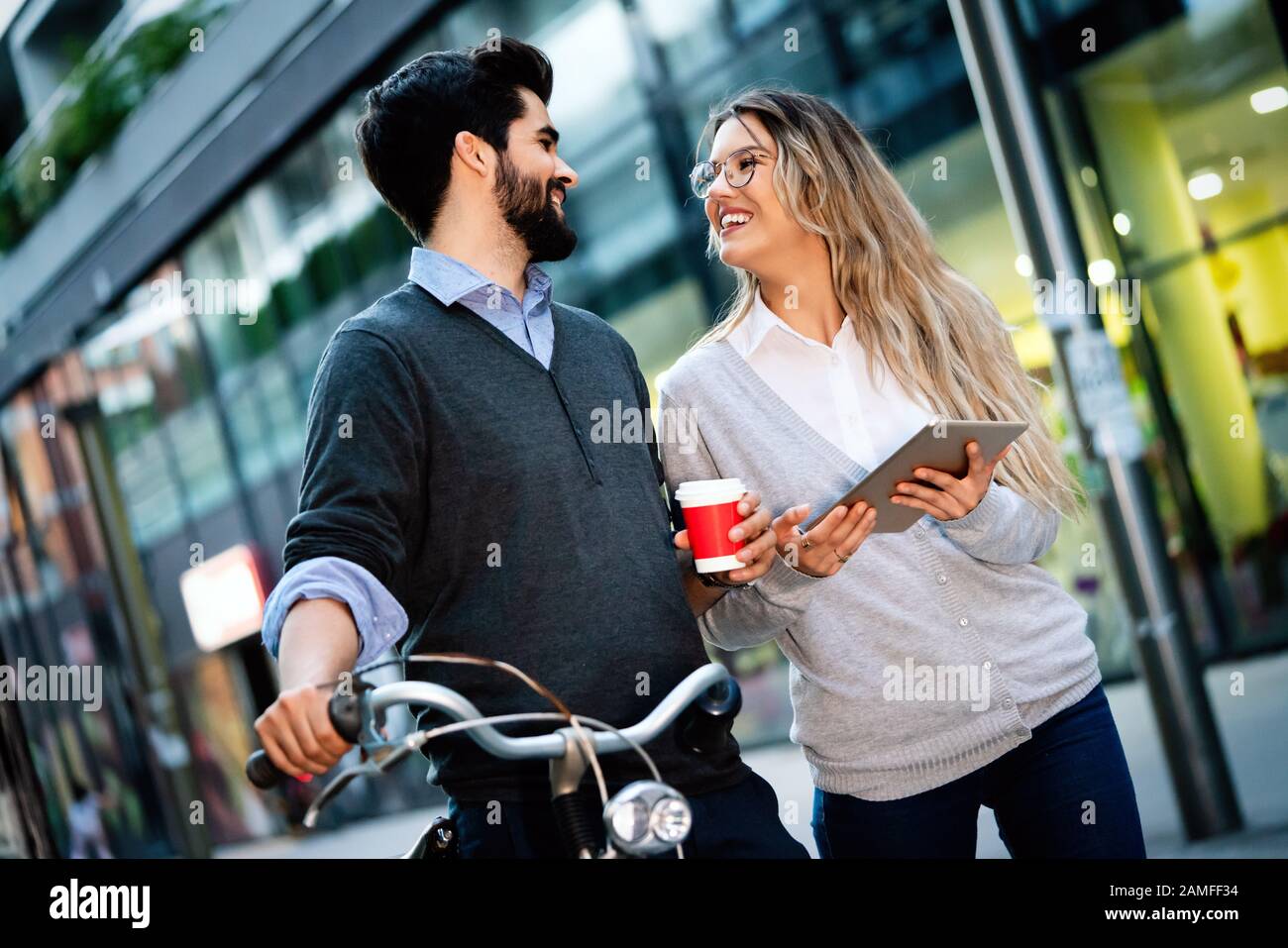 Excited young couple watching content in a tablet outdoo Stock Photo ...