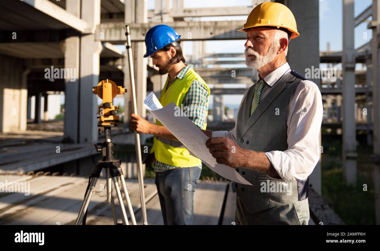 Picture of construction site engineer looking at blueprint Stock Photo ...
