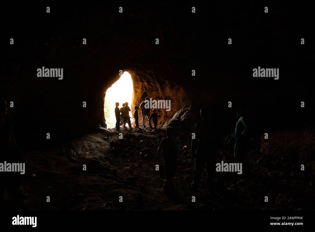 A group of people explore a cave. Photographed in the Carmel mountain ...