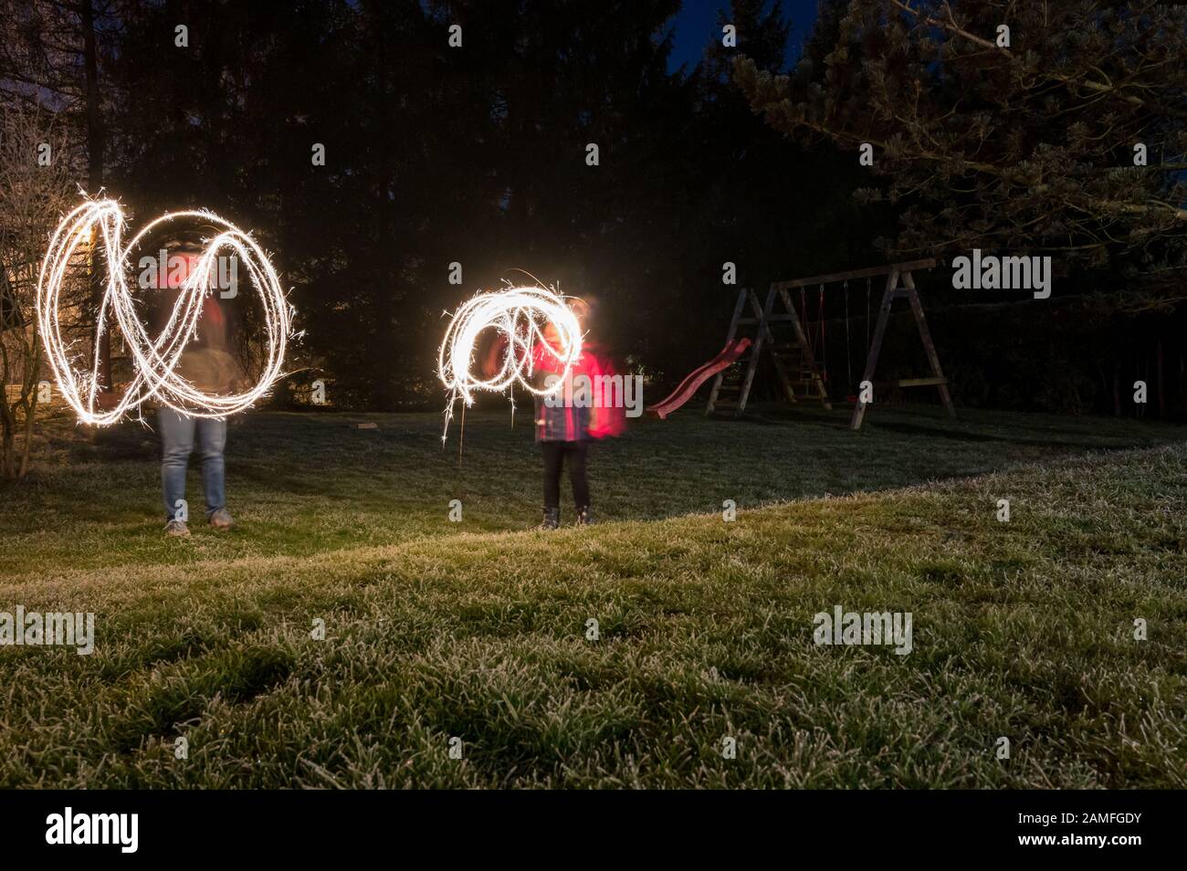 Child light painitng with christmas sparklers outside Stock Photo - Alamy