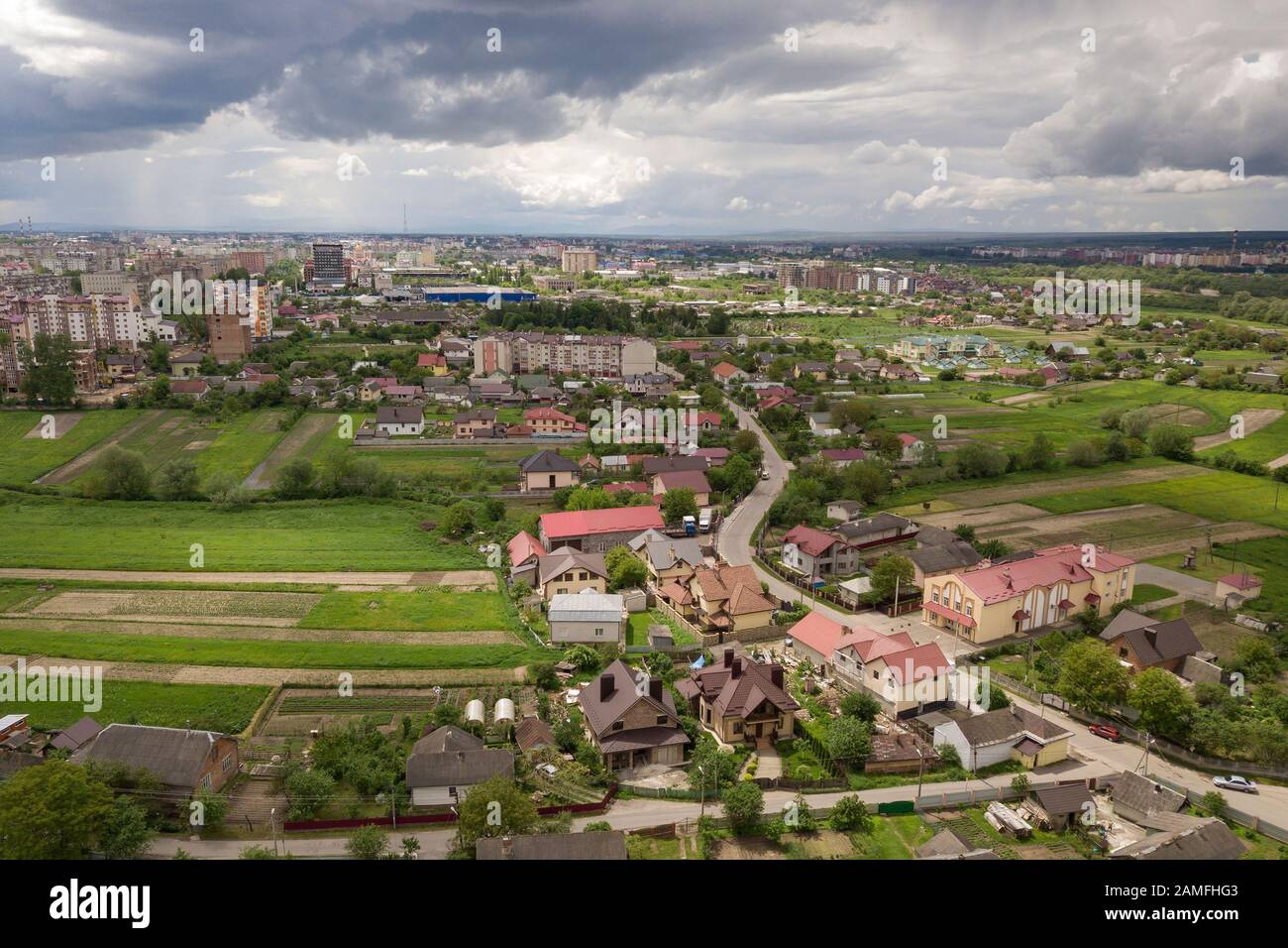 Top down aerial view of town or village with rows of buildings and ...