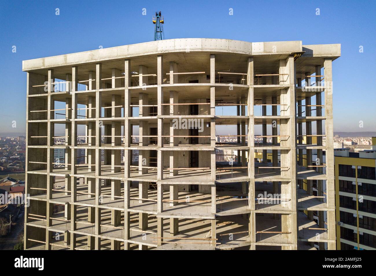 Aerial view of concrete frame of tall apartment building under ...