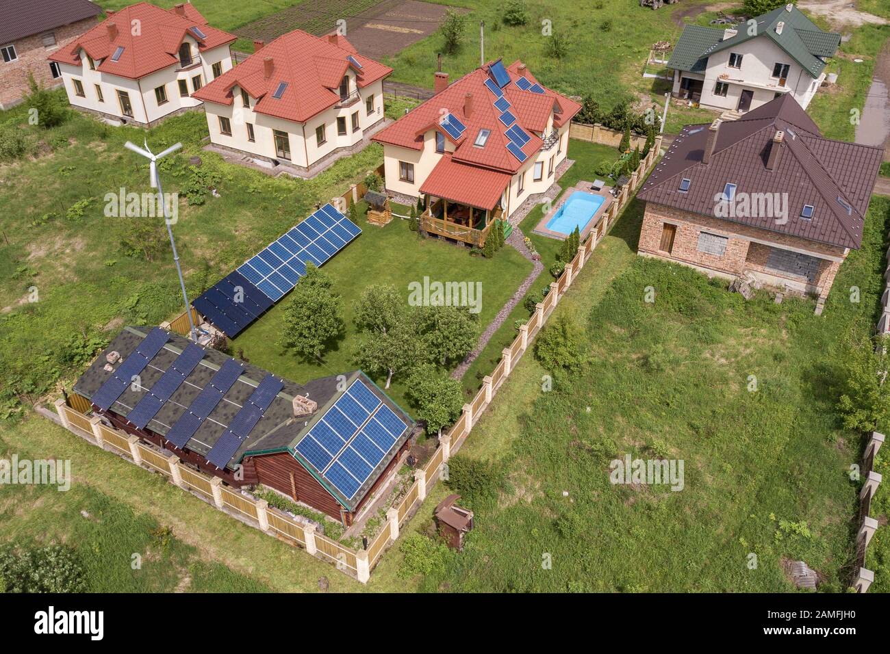 Aerial view of a residential private house with solar panels on roof ...