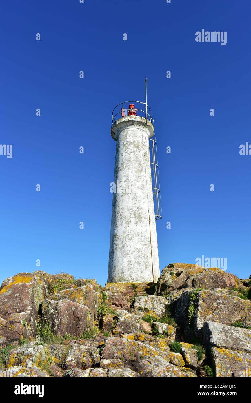 Old white lighthouse on the rocks with blue sky. Muxia, Spain Stock ...