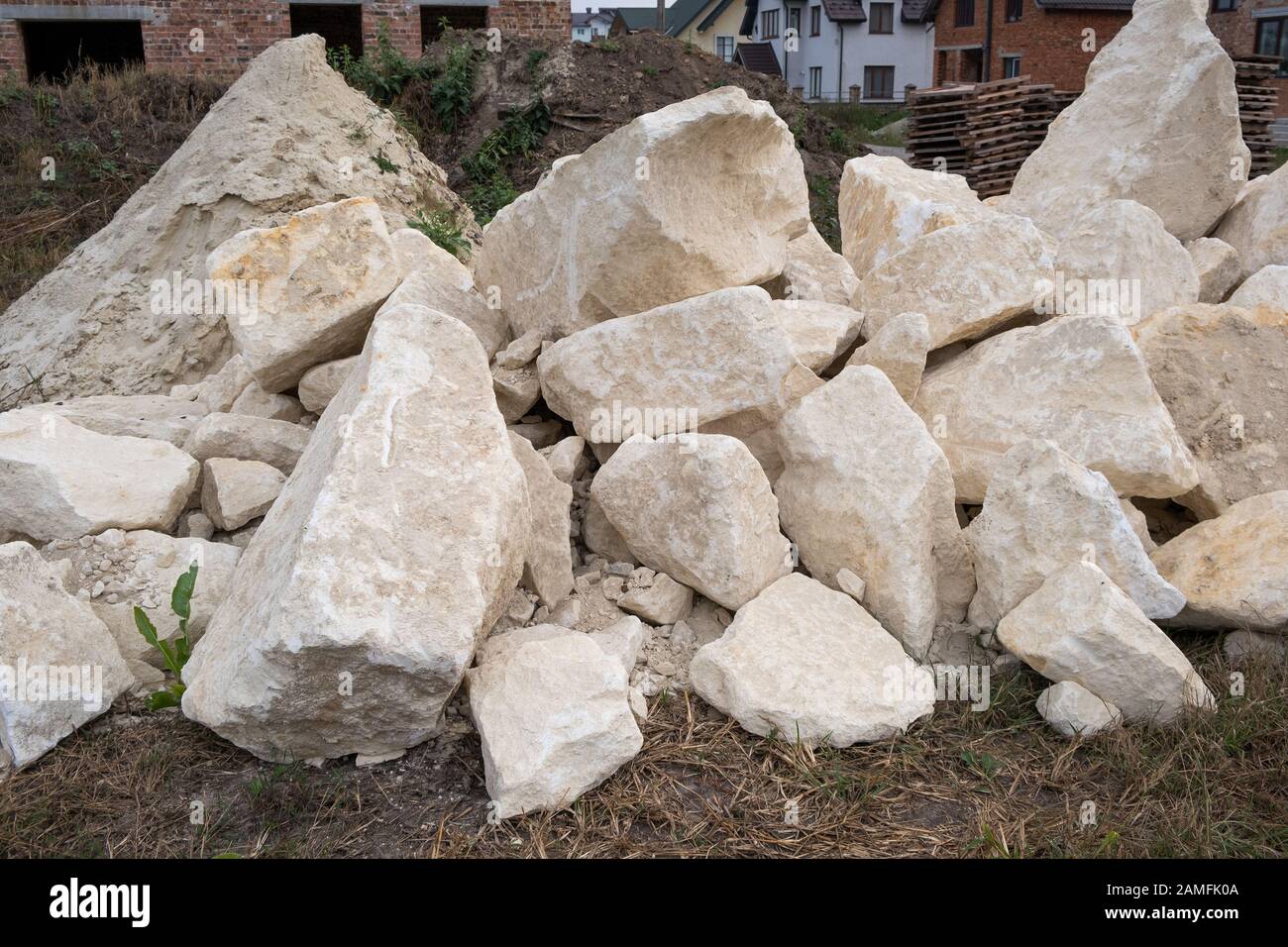 Big pile of large sand stones laying on the ground of construction site ...