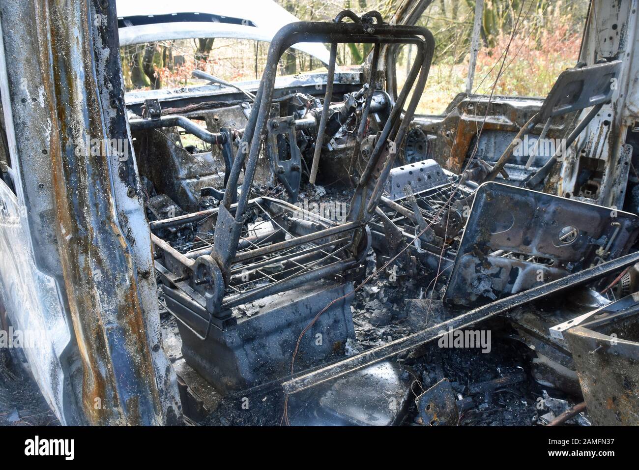Detail of fire damaged van showing remains of seats and dashboard ...