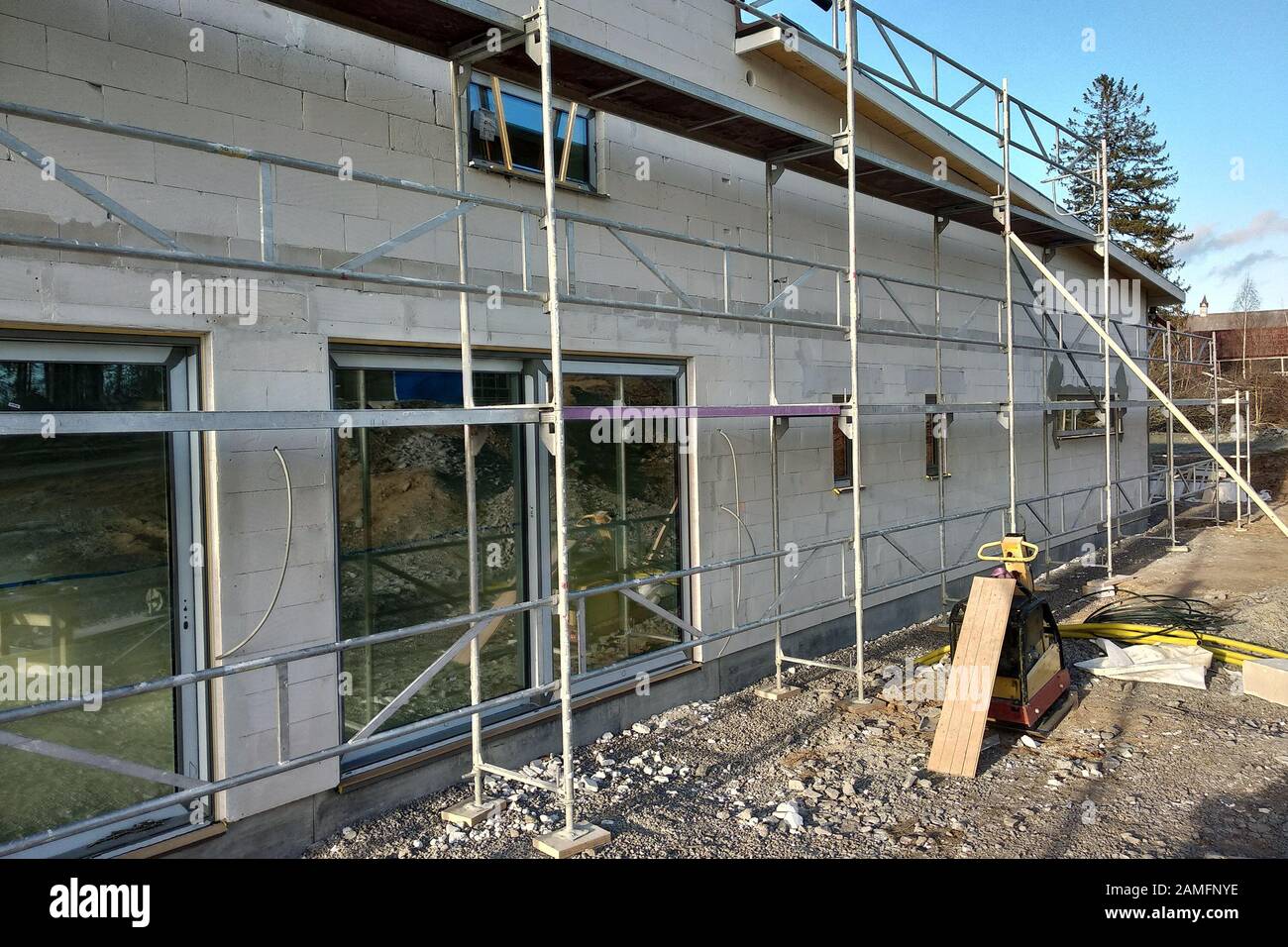Facade of building made from white blocks with big windows under ...