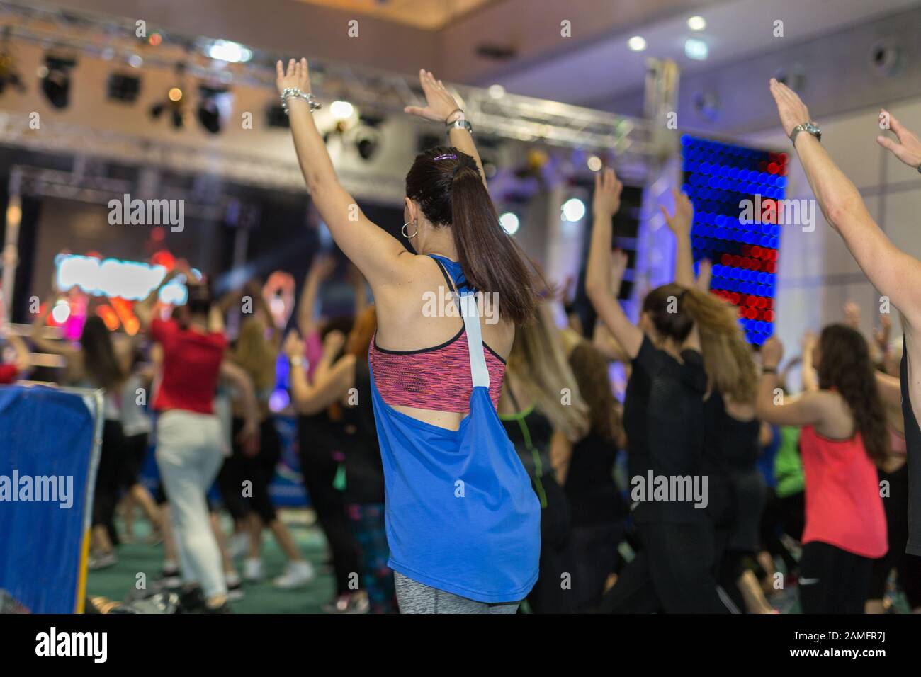 Fitness Workout in Gym: People doing Exercises in Class with Music and ...