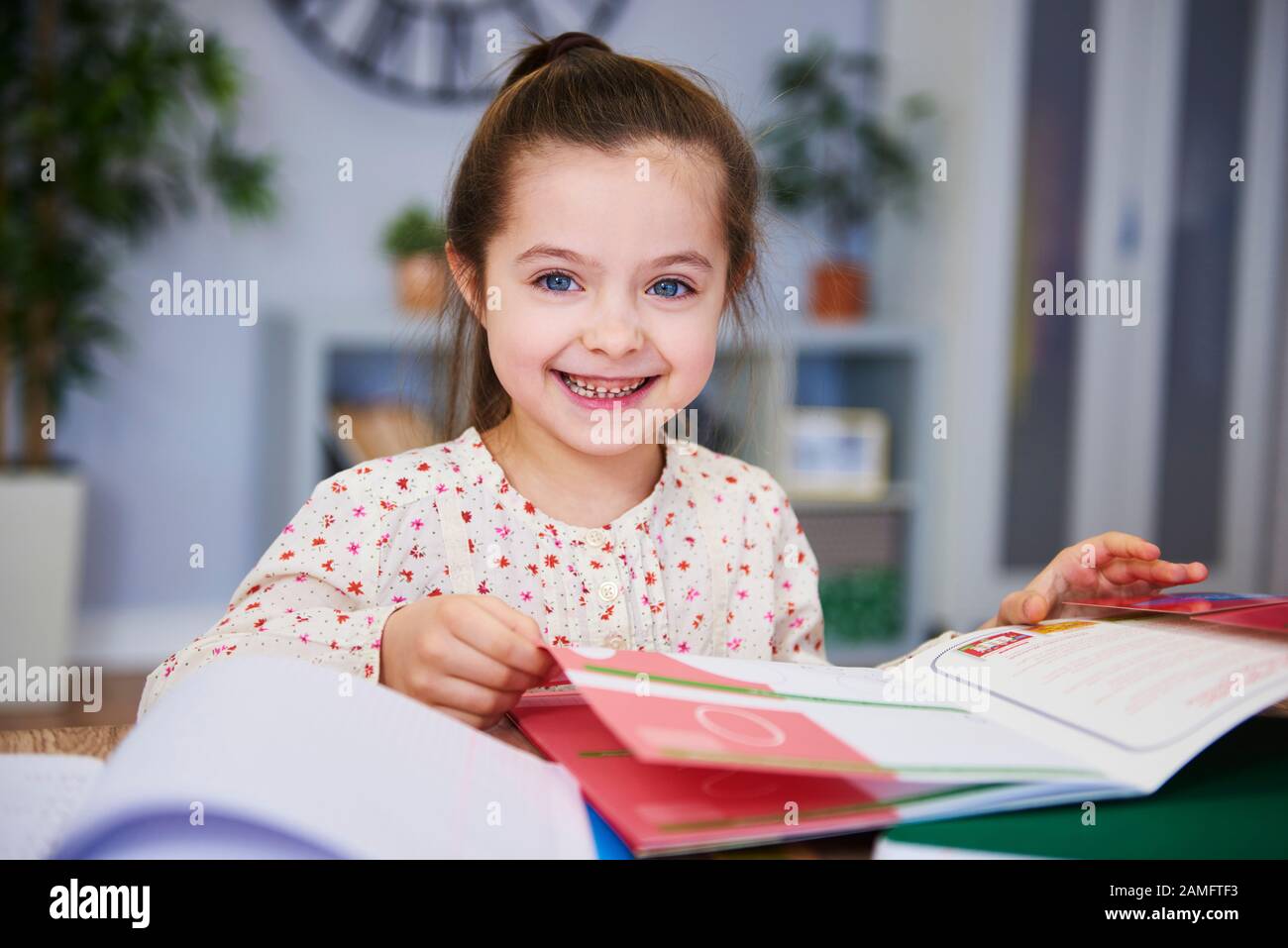 Portrait of smiling child studying at home Stock Photo - Alamy