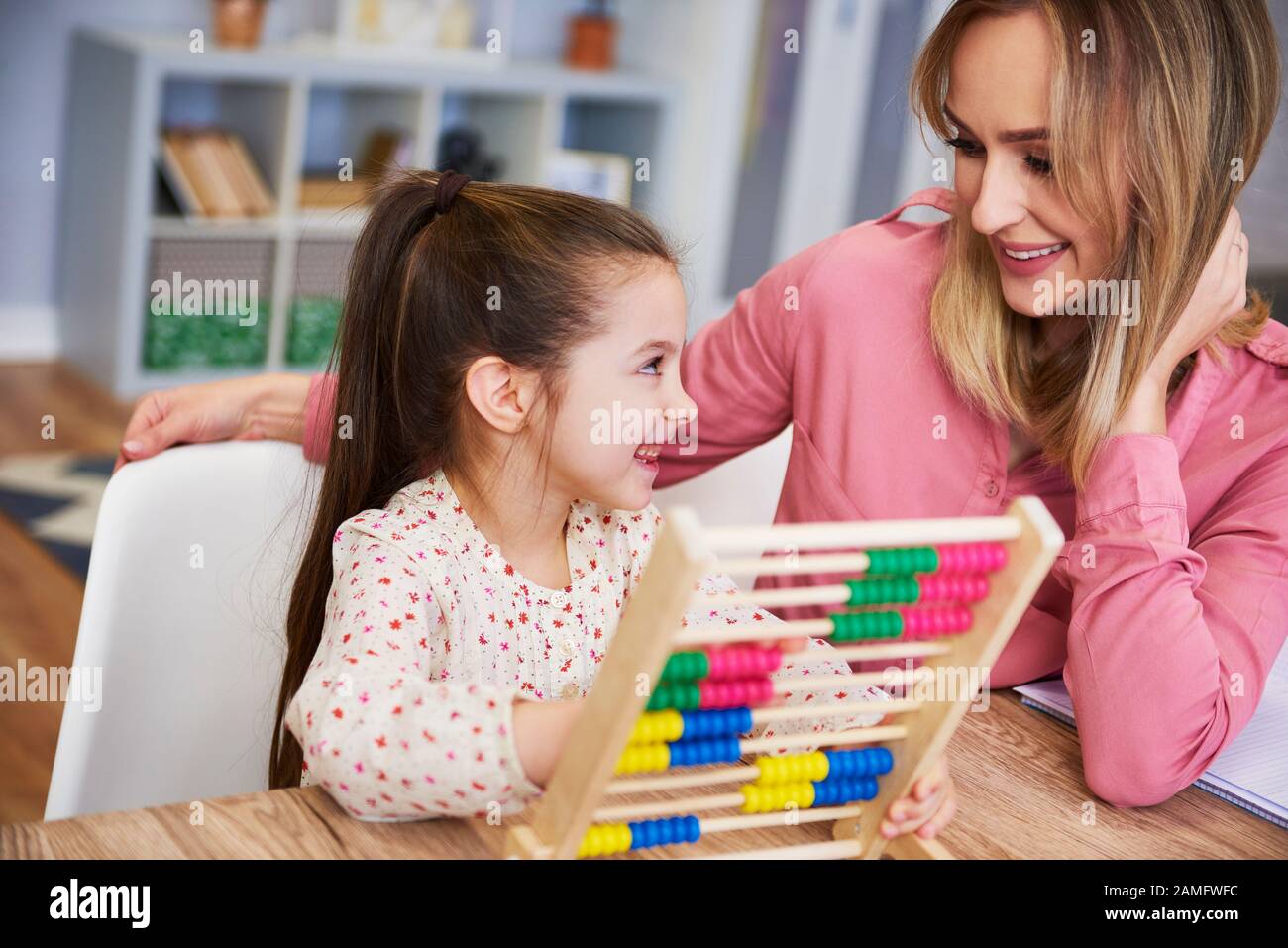 Happy girl learning to count at home Stock Photo - Alamy