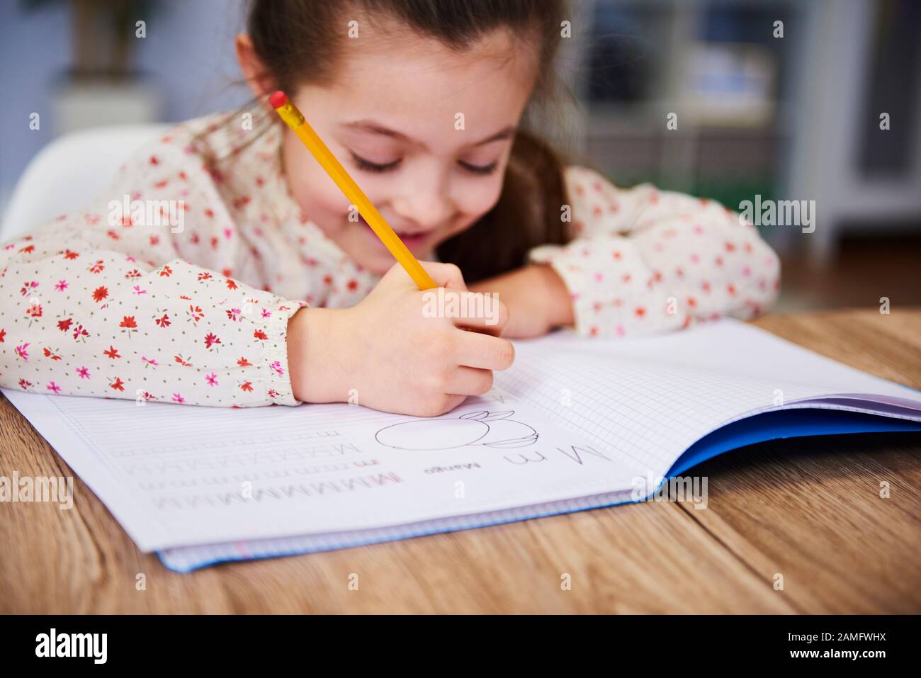 Girl's hand writing in her notebook Stock Photo - Alamy