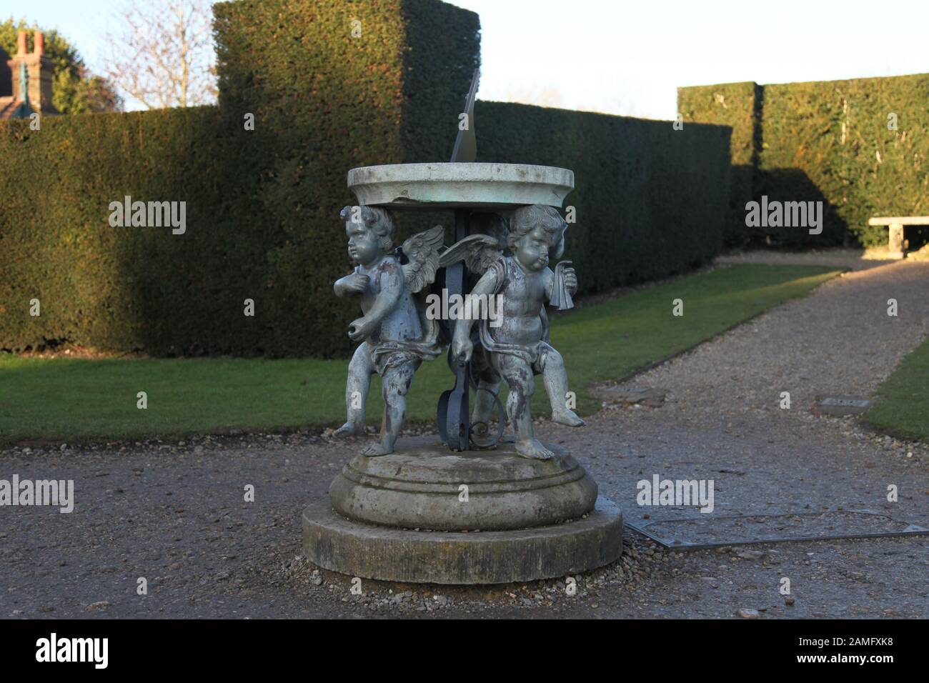 Three Cherub sundial located in the gardens of Polesden Lacey, a ...