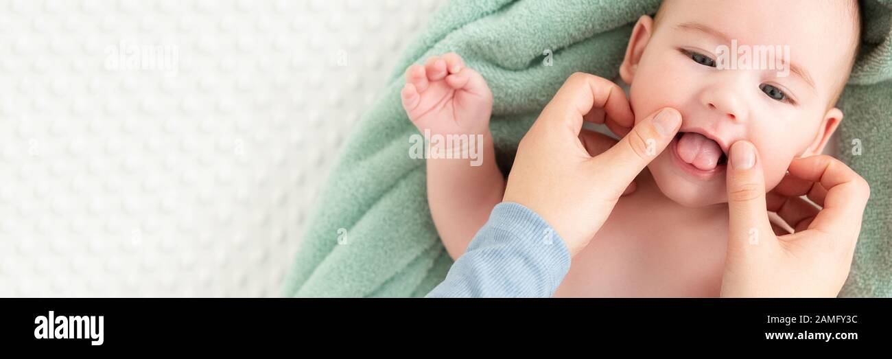 Baby face massage banner with copy space. Mother gently stroking baby ...