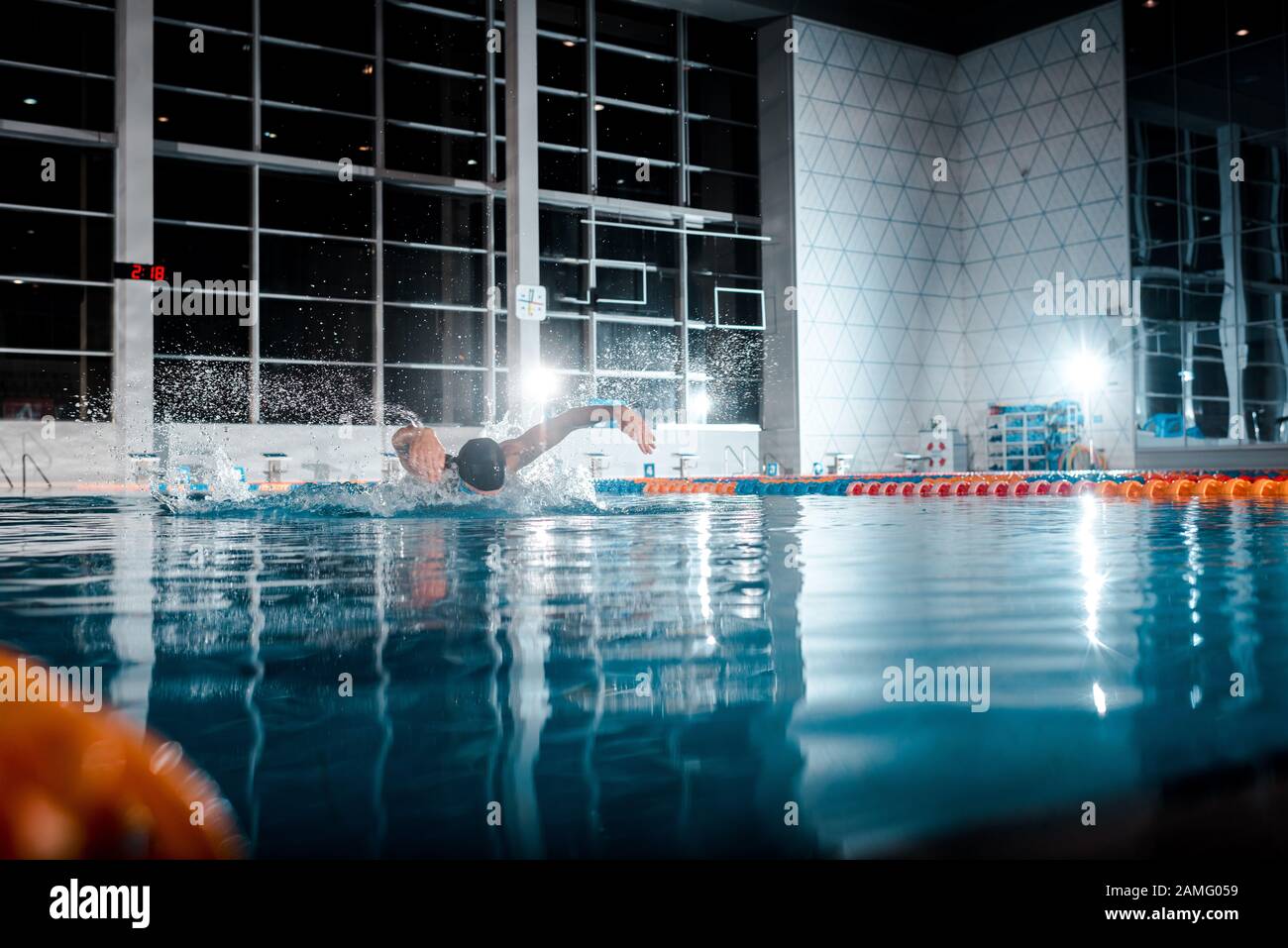 selective focus of sportsman swimming butterfly stroke in swimming pool ...