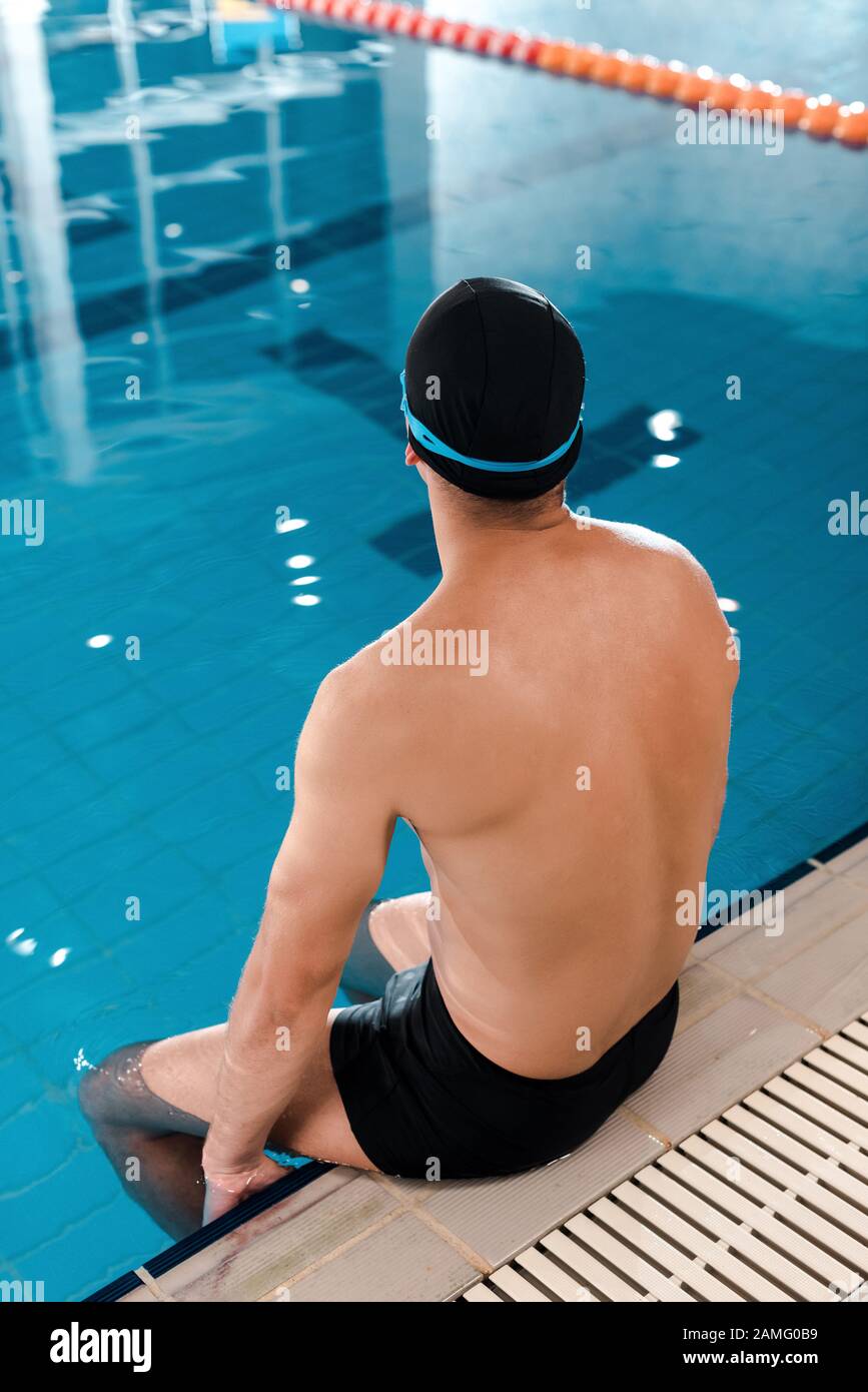 back view of swimmer sitting near swimming pool Stock Photo - Alamy