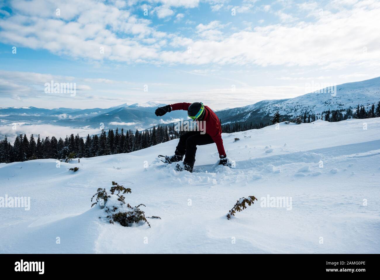 snowboarder falling while riding on slope in mountains Stock Photo - Alamy