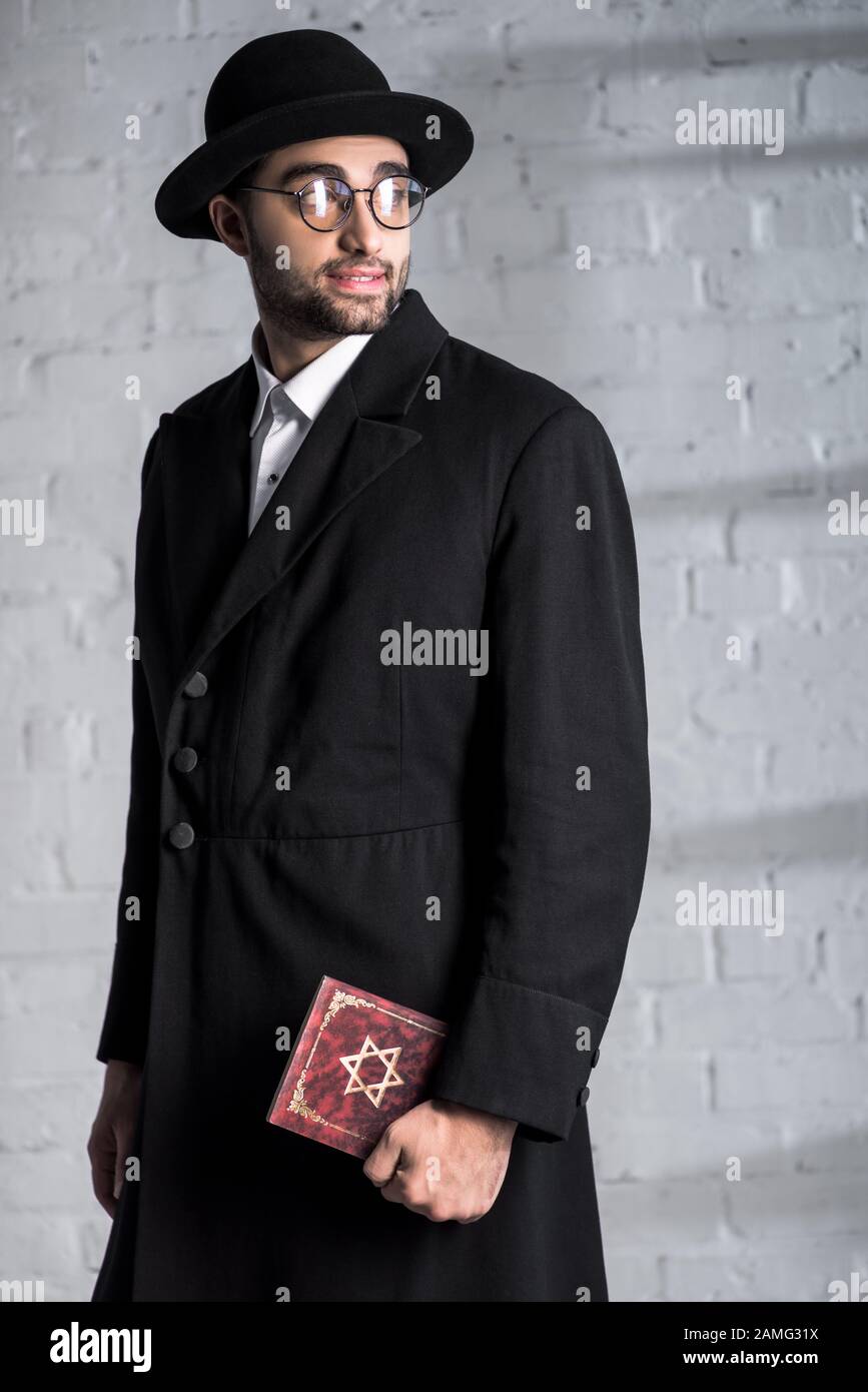 handsome and smiling jewish man in glasses holding tanakh Stock Photo ...