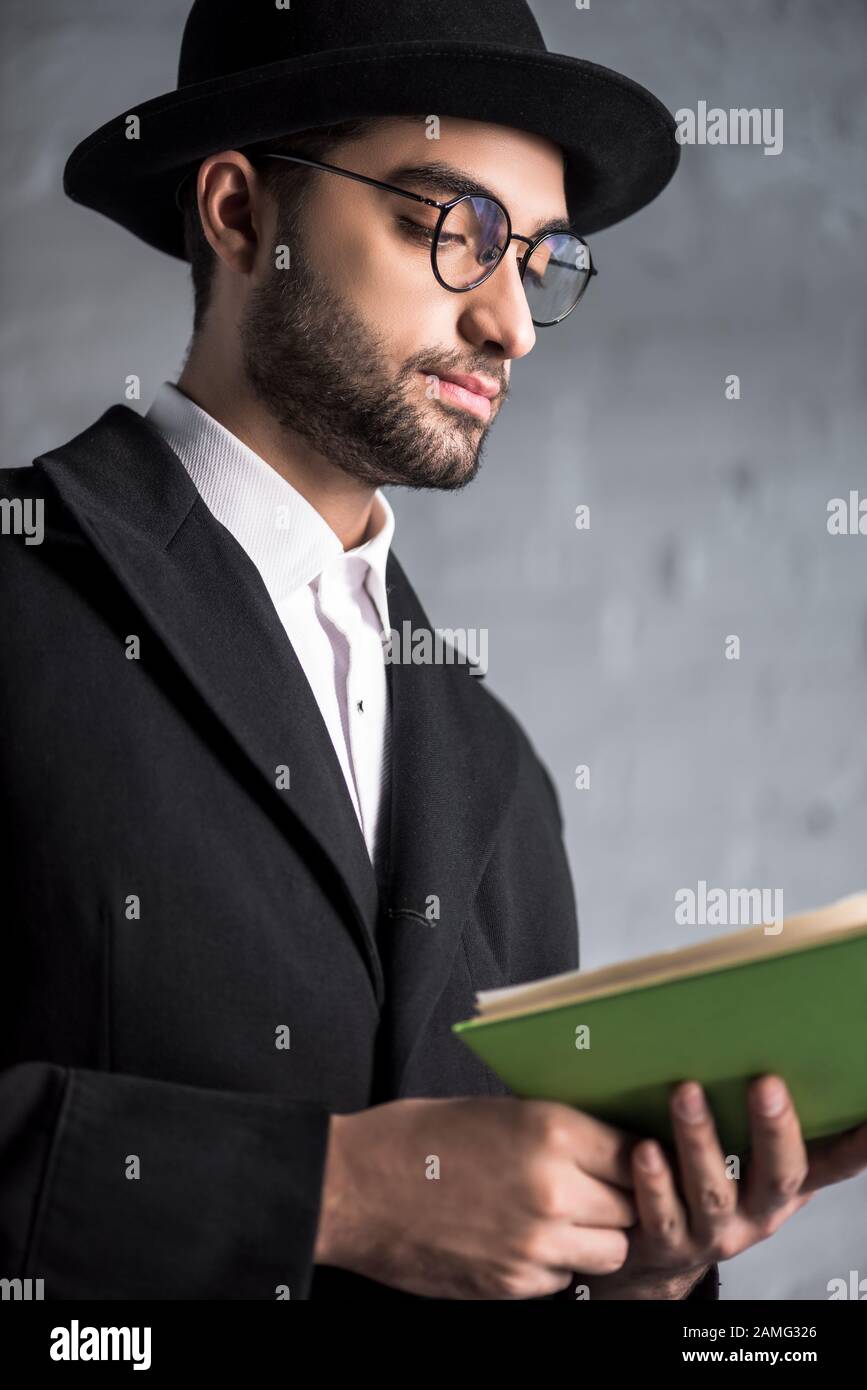 handsome and young jewish man in glasses reading book Stock Photo - Alamy