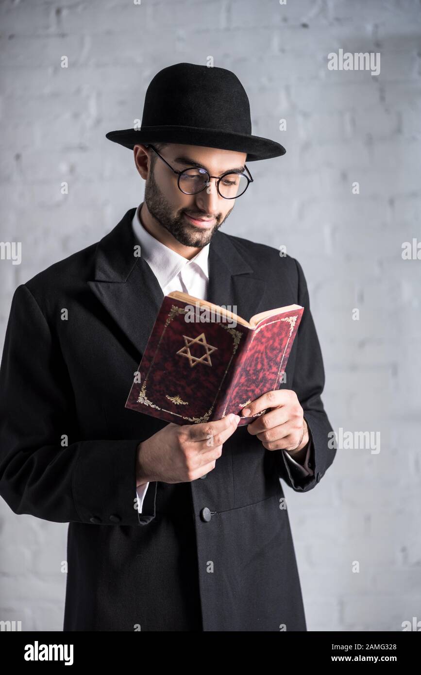 handsome and smiling jewish man in glasses reading tanakh Stock Photo ...