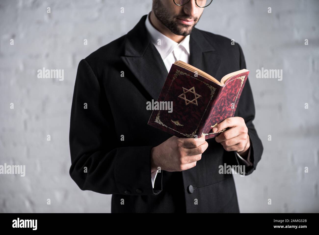 cropped view of young jewish man reading tanakh Stock Photo - Alamy