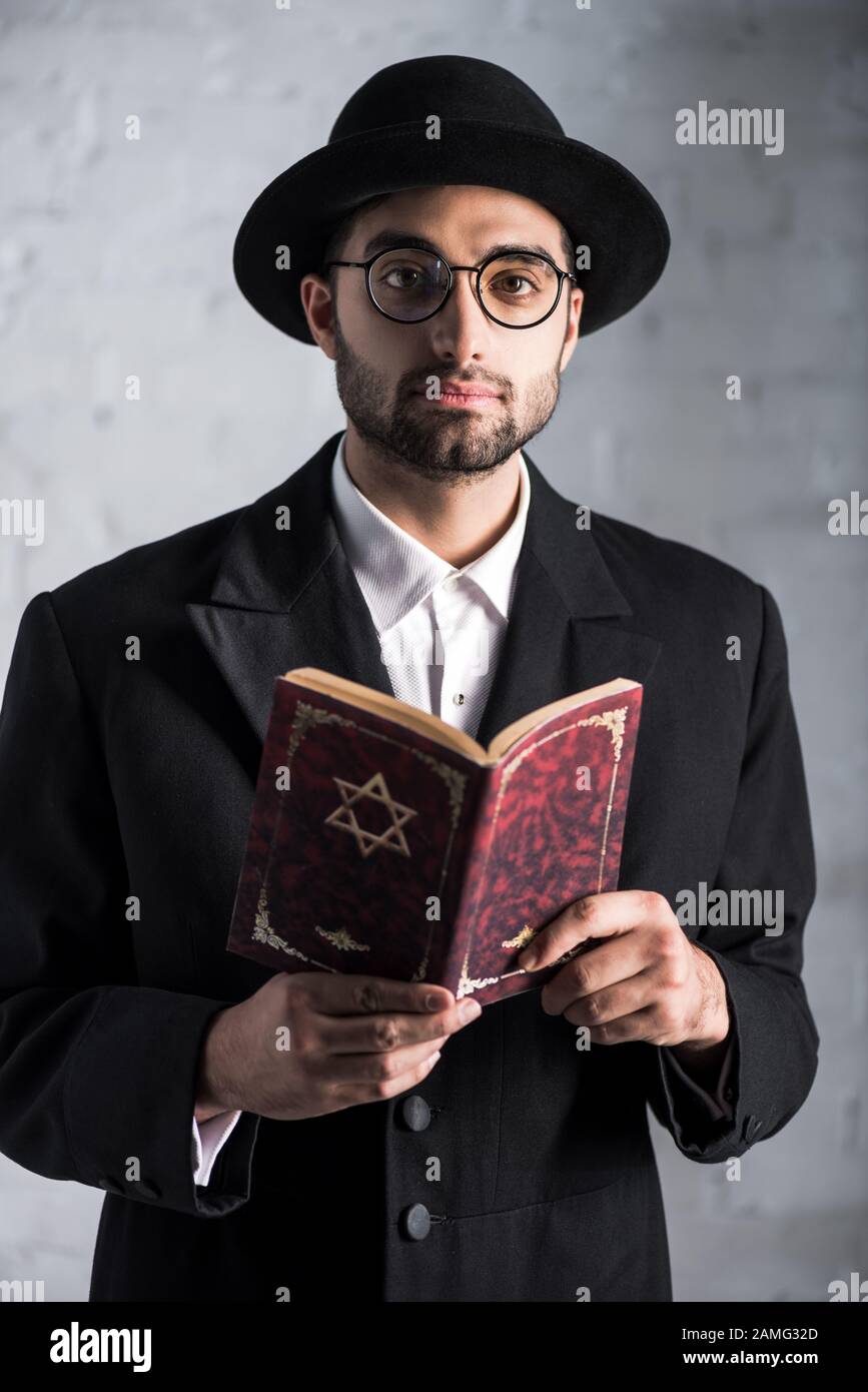 handsome and young jewish man in glasses holding tanakh Stock Photo - Alamy