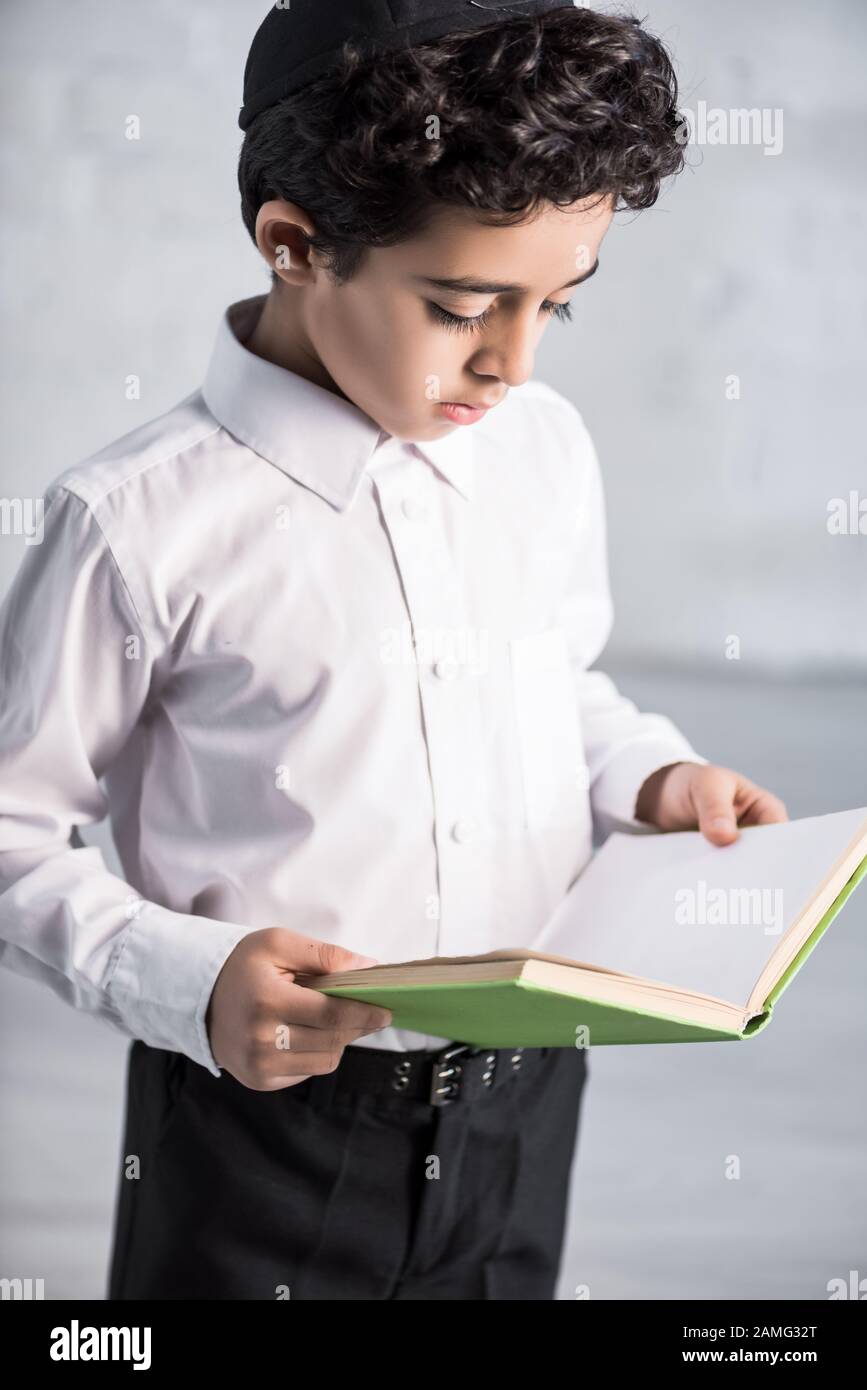 cute jewish boy in white shirt reading book Stock Photo - Alamy