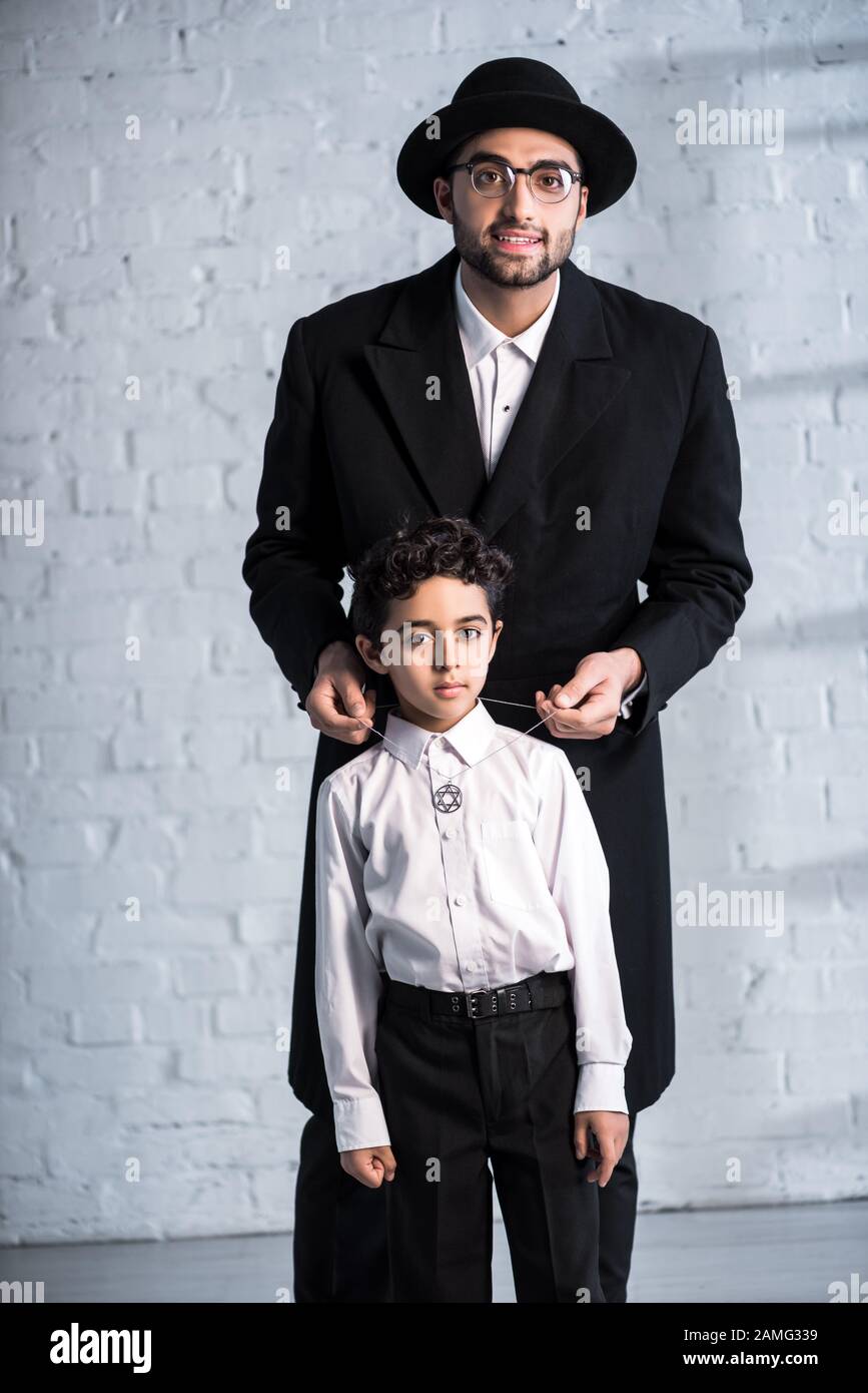 smiling jewish father wearing star of david necklace on son Stock Photo ...