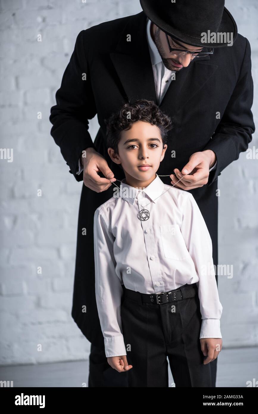 handsome jewish father wearing star of david necklace on son Stock ...