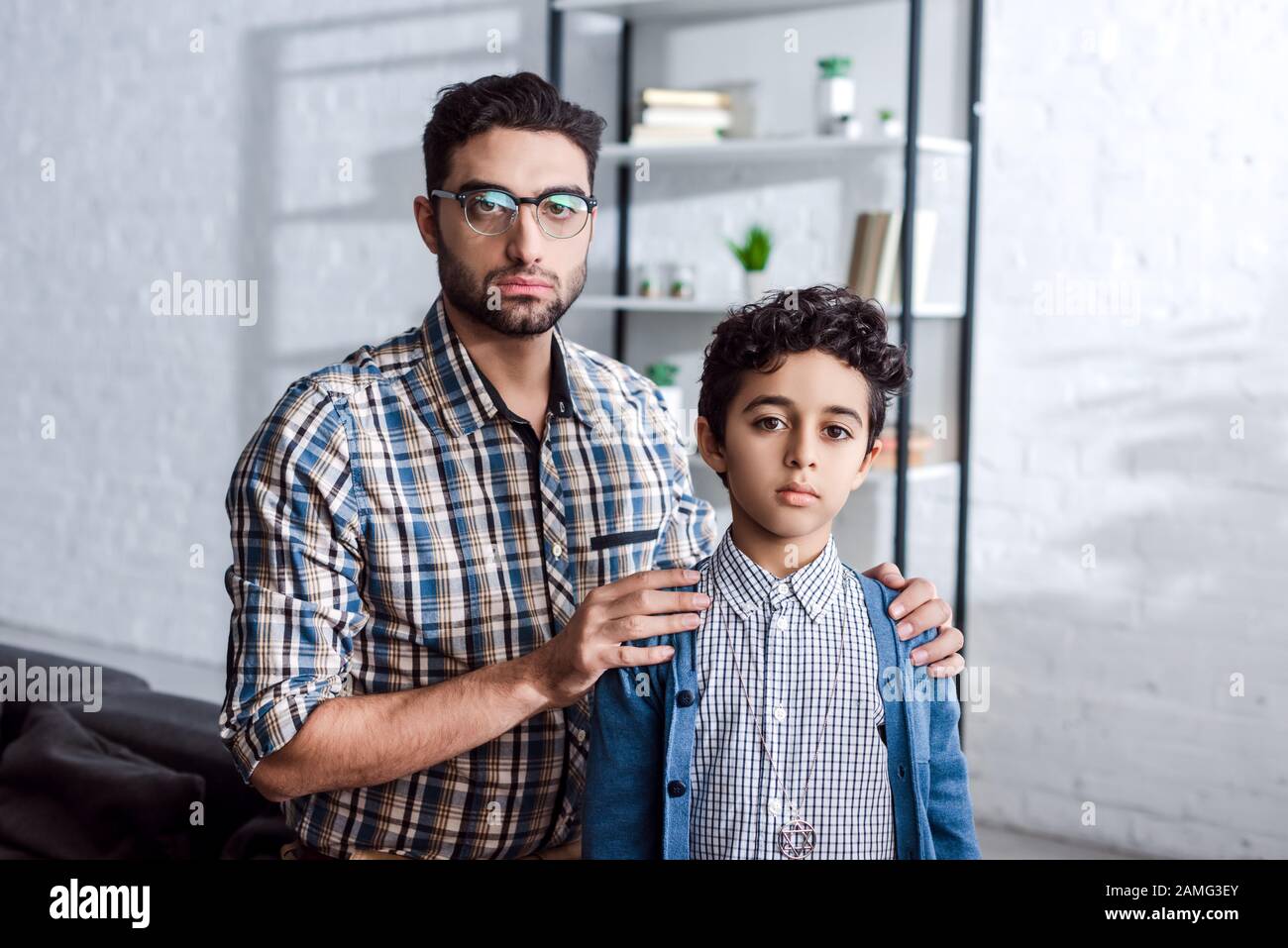 jewish father hugging son and looking at camera in apartment Stock ...