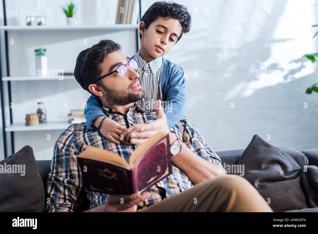jewish father holding tanakh and talking with son in apartment Stock ...