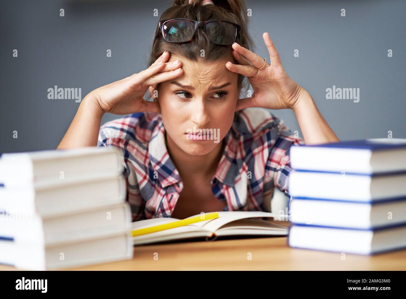 Tired female student learning till late at home Stock Photo - Alamy