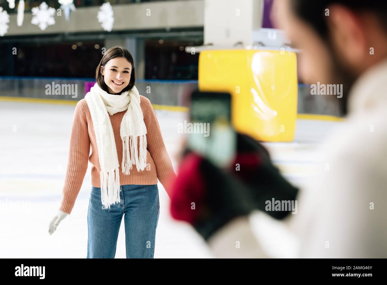 selective focus of boyfriend taking photo of smiling girlfriend on ...