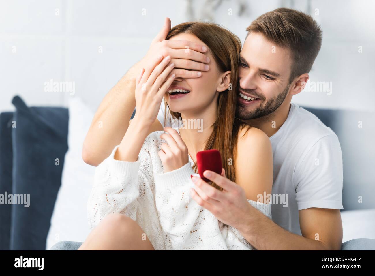 smiling man doing marriage proposal and obscuring face of woman Stock ...