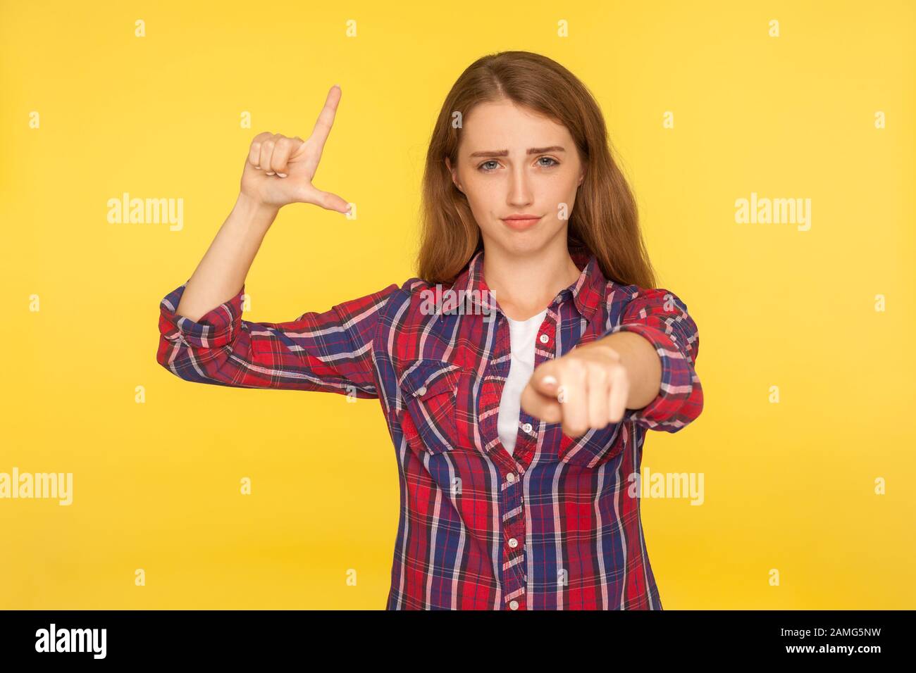 Your failure! Portrait of ginger girl in shirt showing loser gesture, L ...