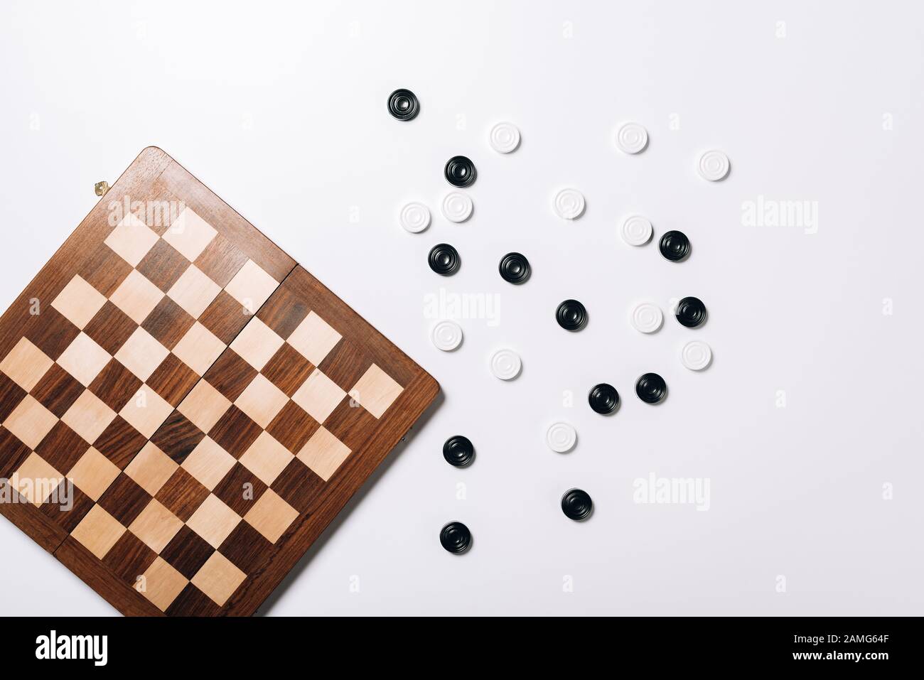 Top view of checkers by wooden checkerboard on white background Stock ...