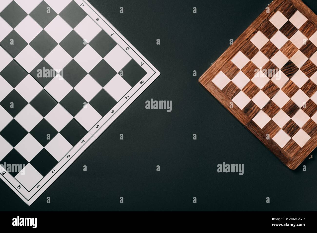 Top view of checkerboards isolated on black Stock Photo - Alamy