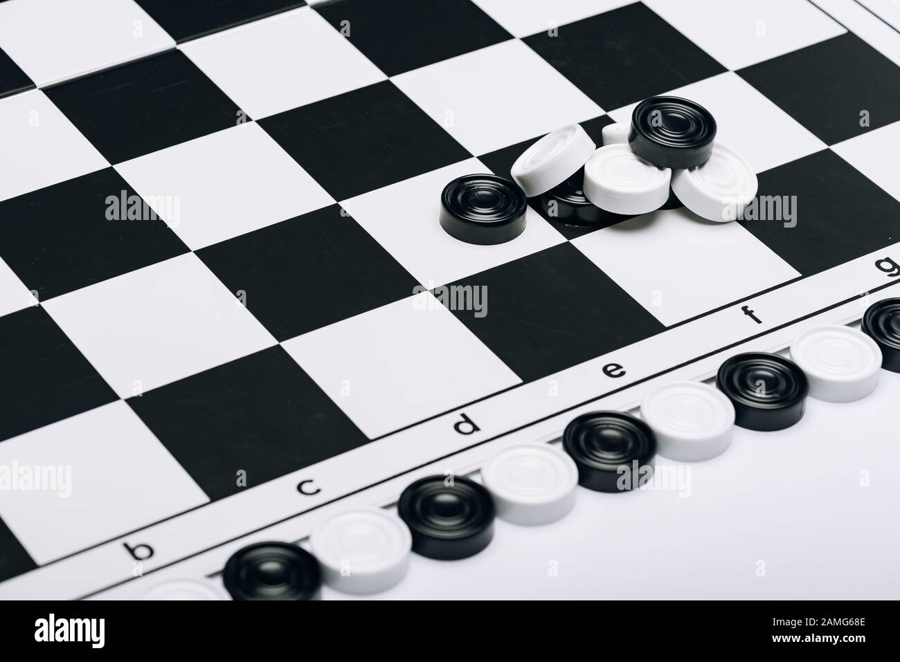 High angle view of checkers on checkerboard isolated on white Stock ...