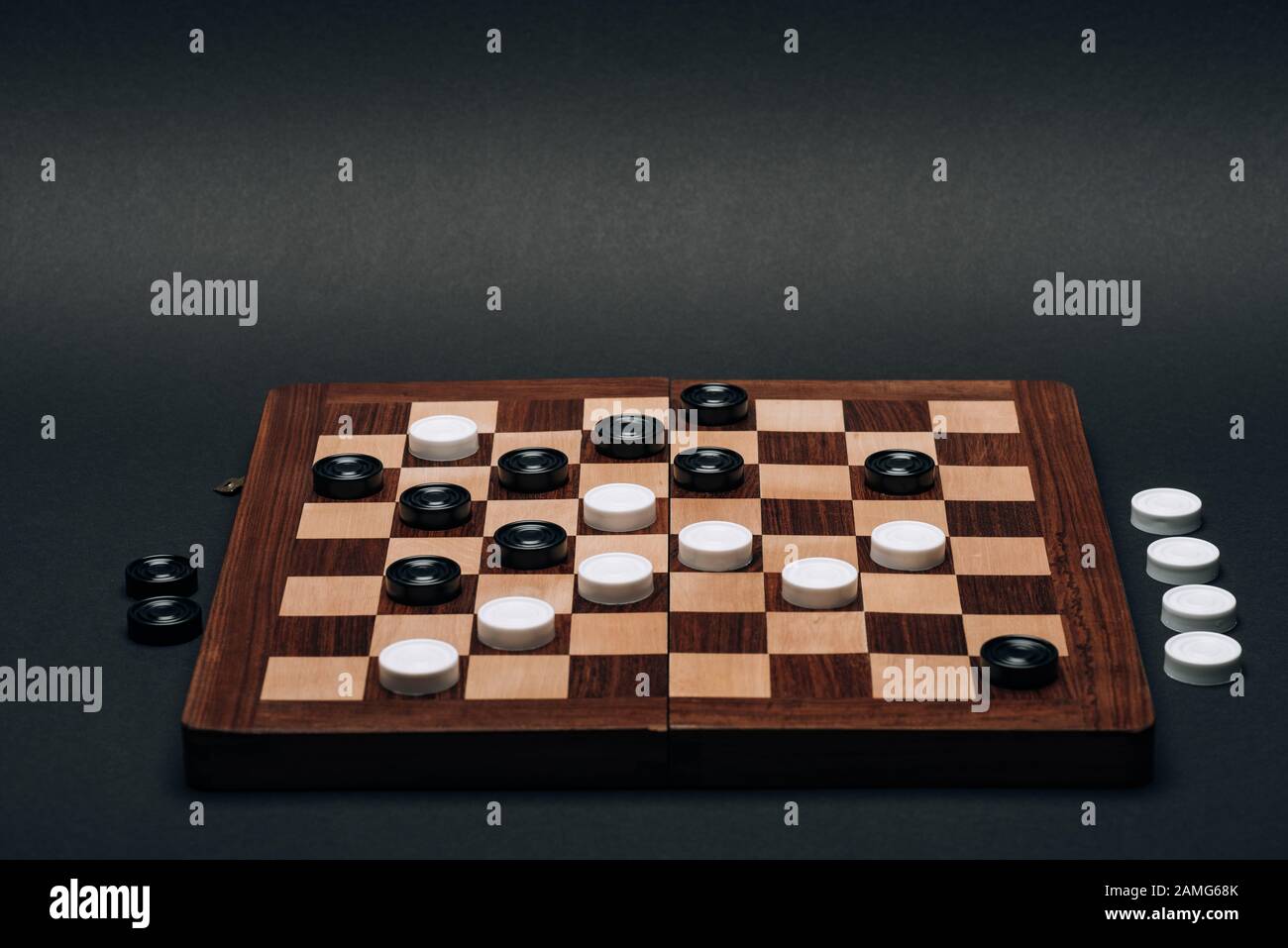 Checkerboard with black and white checkers isolated on black Stock ...