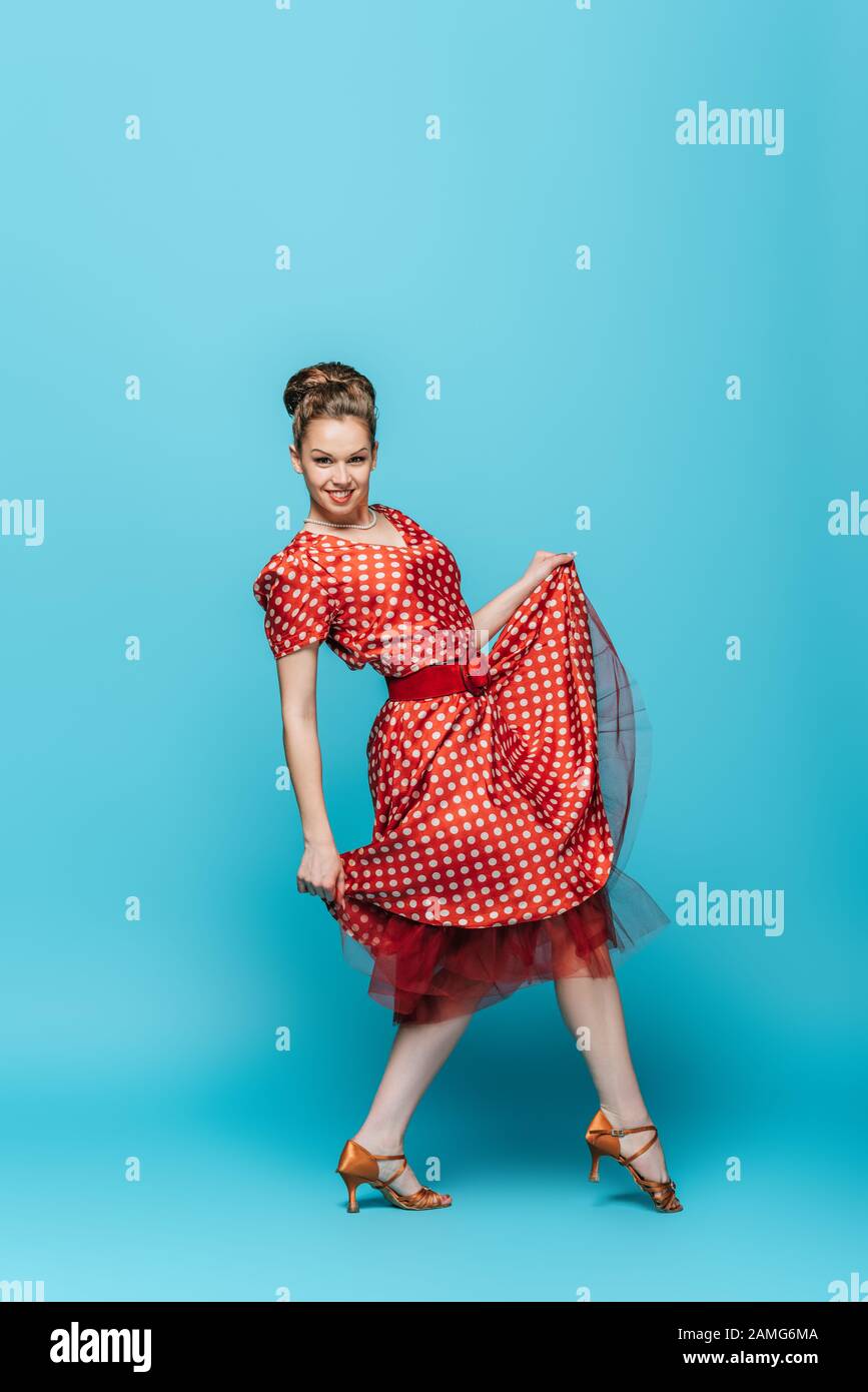 happy, cheerful dancer looking at camera while dancing boogie-woogie on ...