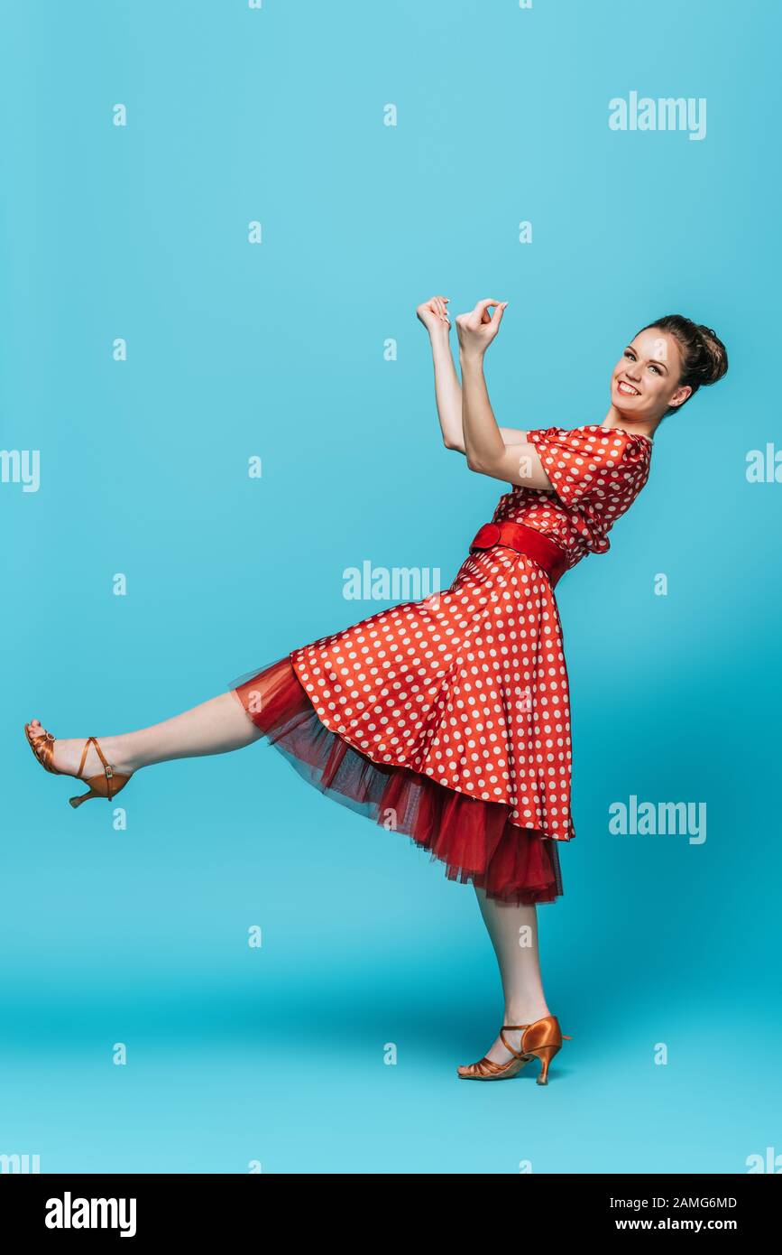 pretty, stylish dancer looking at camera while dancing boogie-woogie on ...