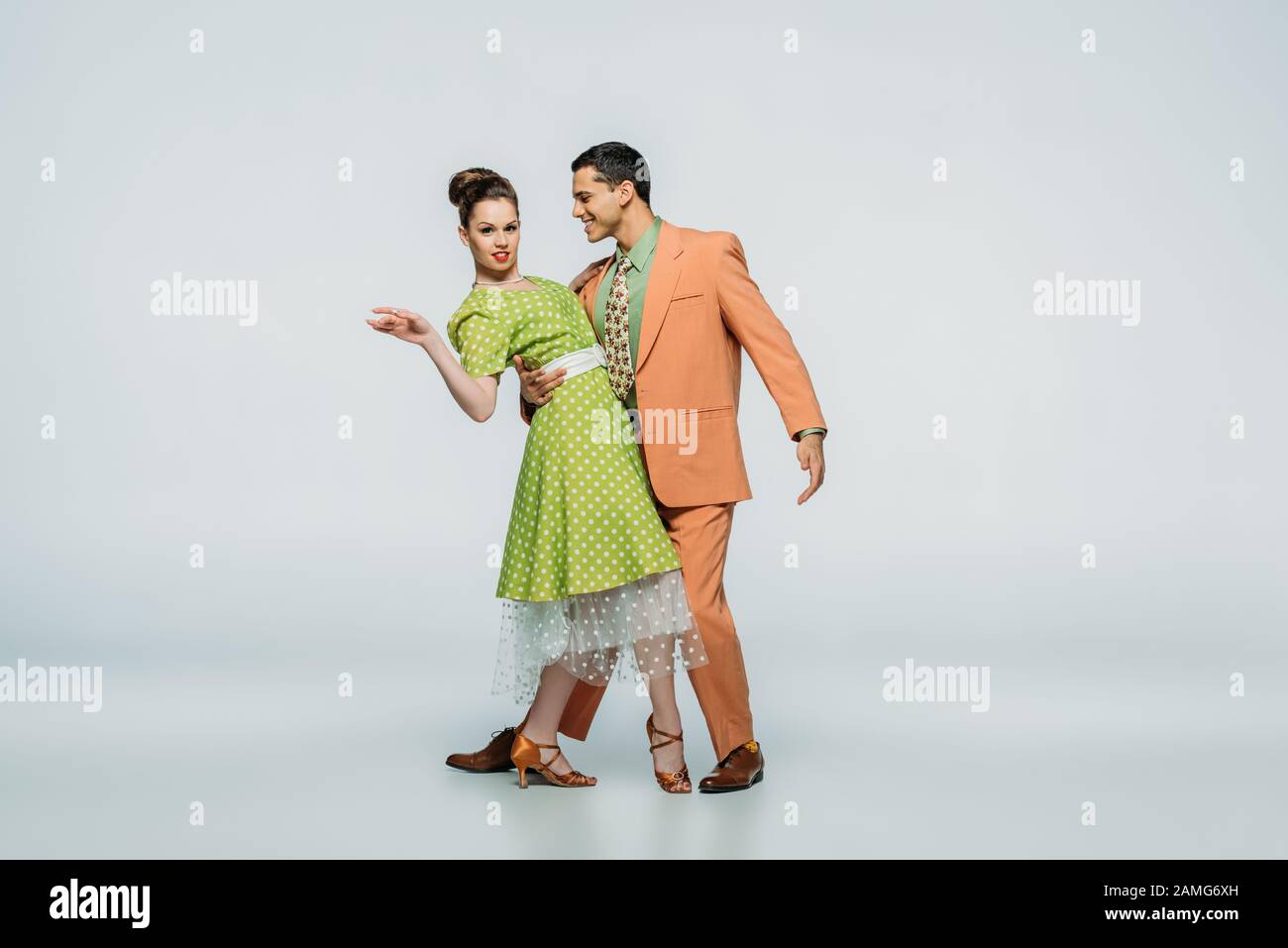 stylish dancers dancing boogie-woogie on grey background Stock Photo ...