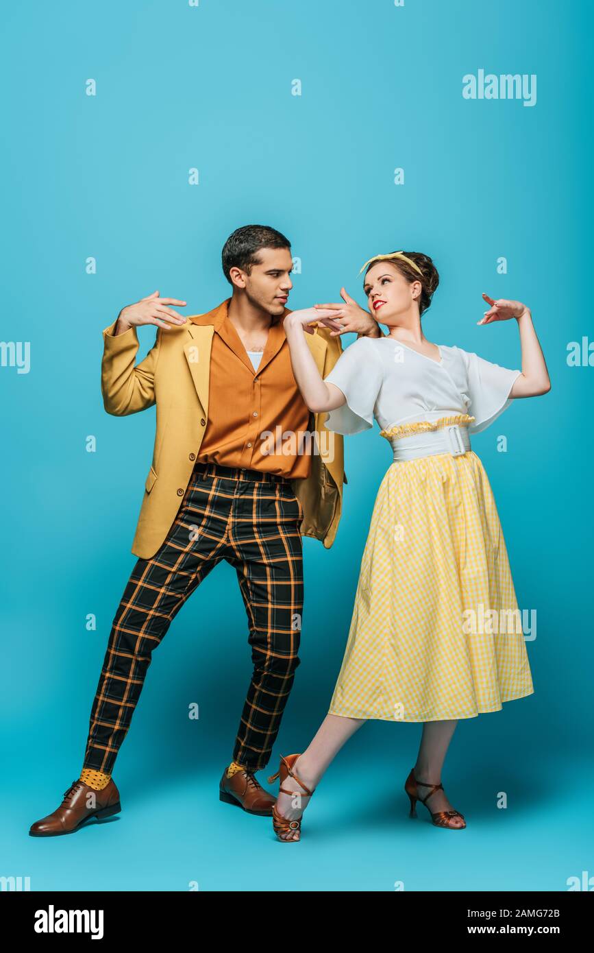 stylish dancers looking at each other while dancing boogie-woogie on ...