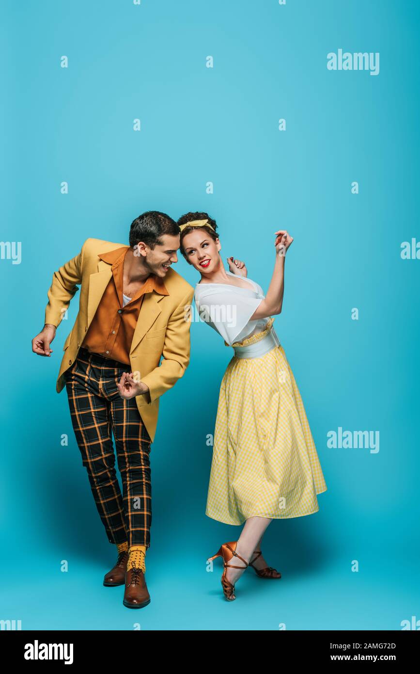 cheerful dancers looking at each other while dancing boogie-woogie on ...